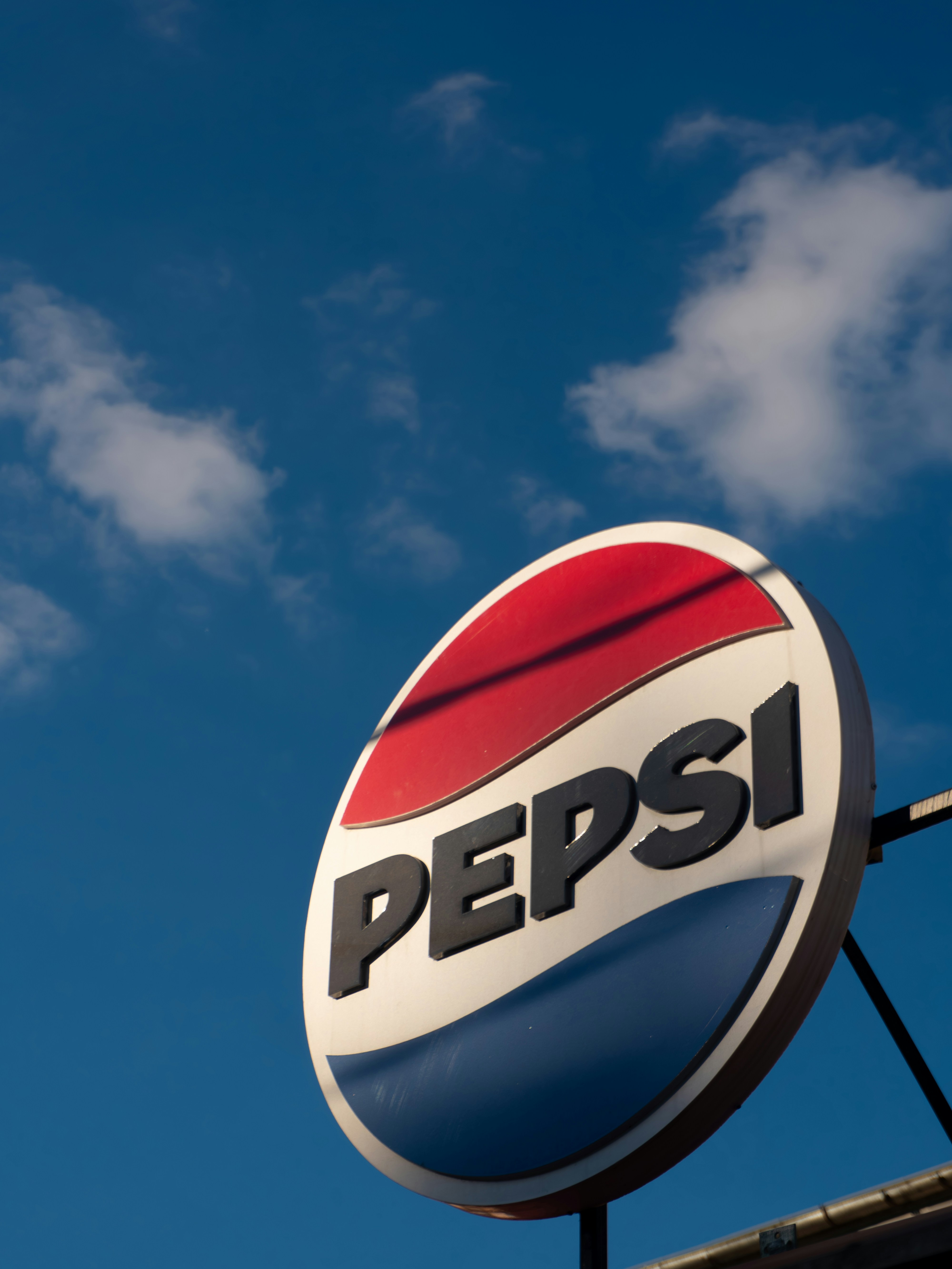 Floating Emblem: Pepsi Sign Against a Clear Sky