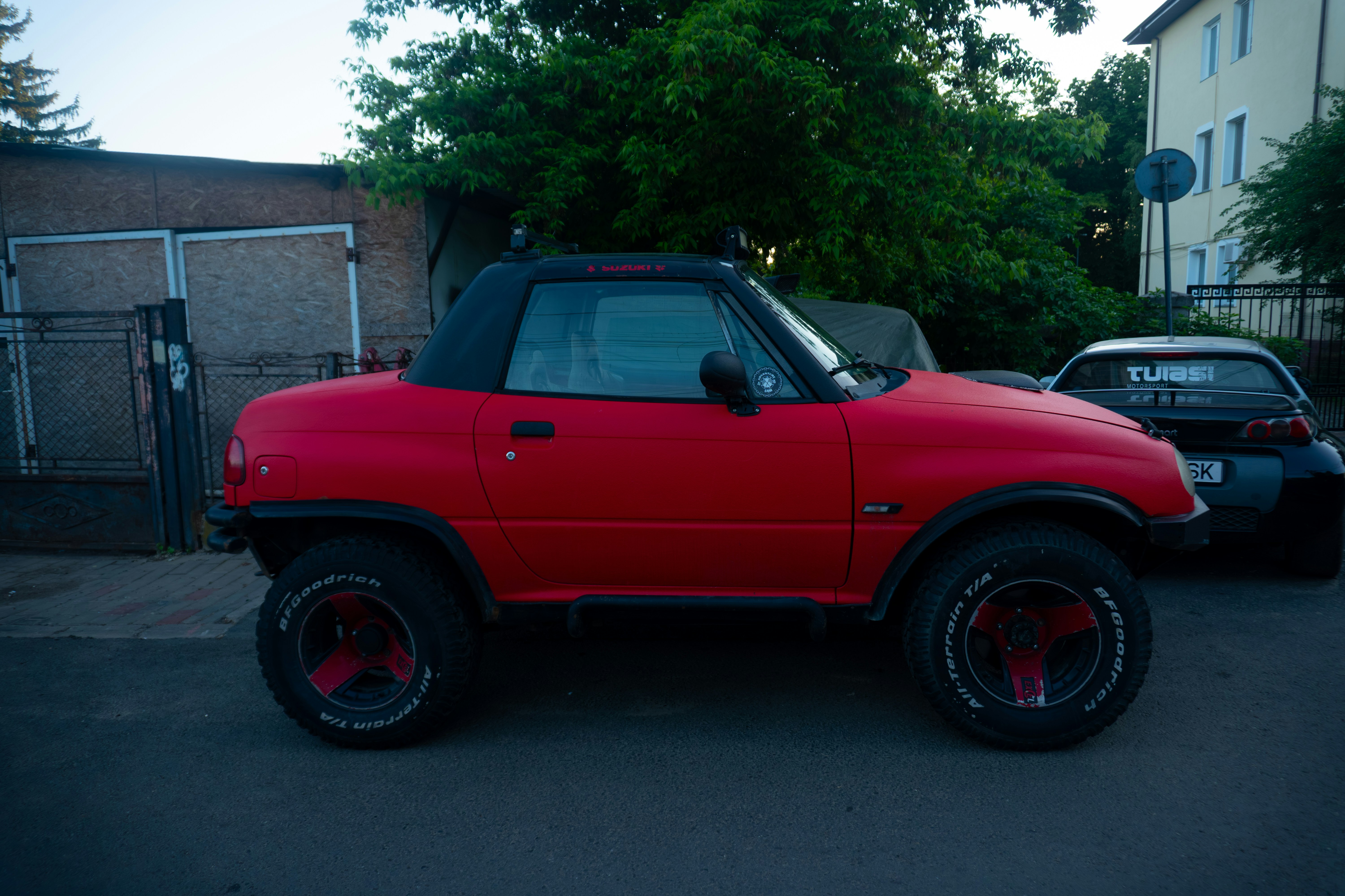 Red Compact: A Convertible Classic Anchoring a Quiet Street