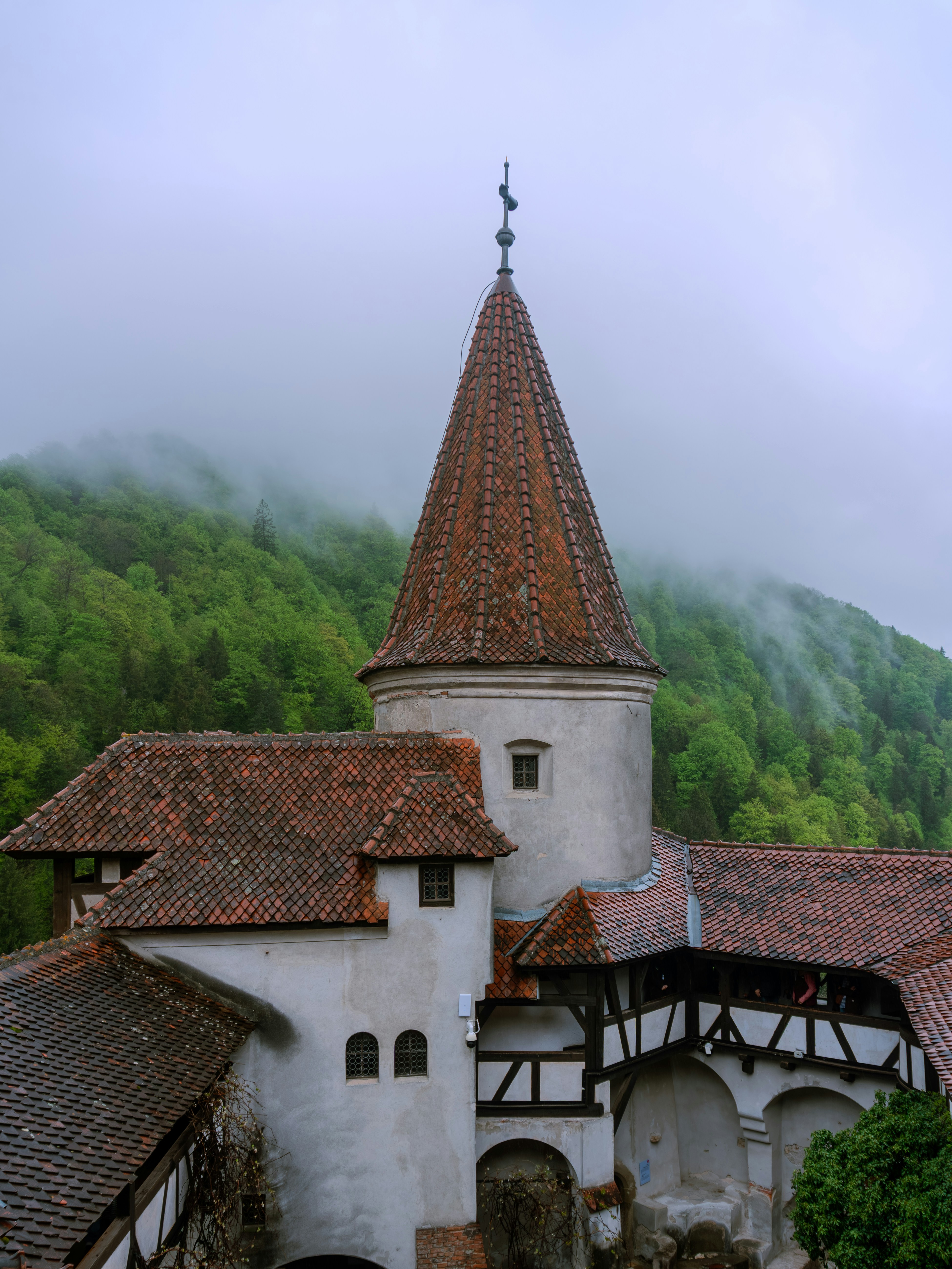 Towering Tile Spire Above a Fog-Kissed Monastery Courtyard