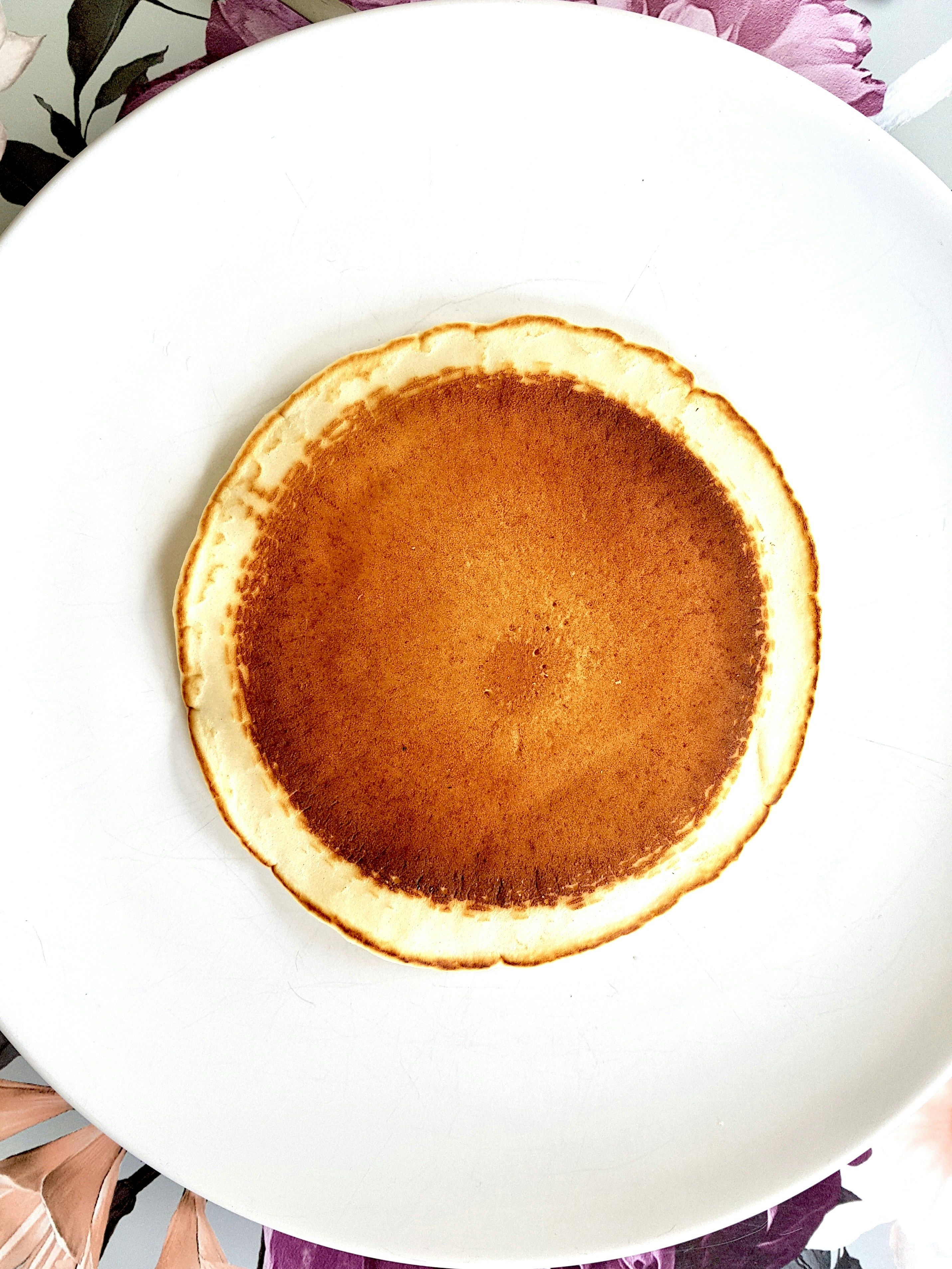 Golden Round Pancake on White Plate