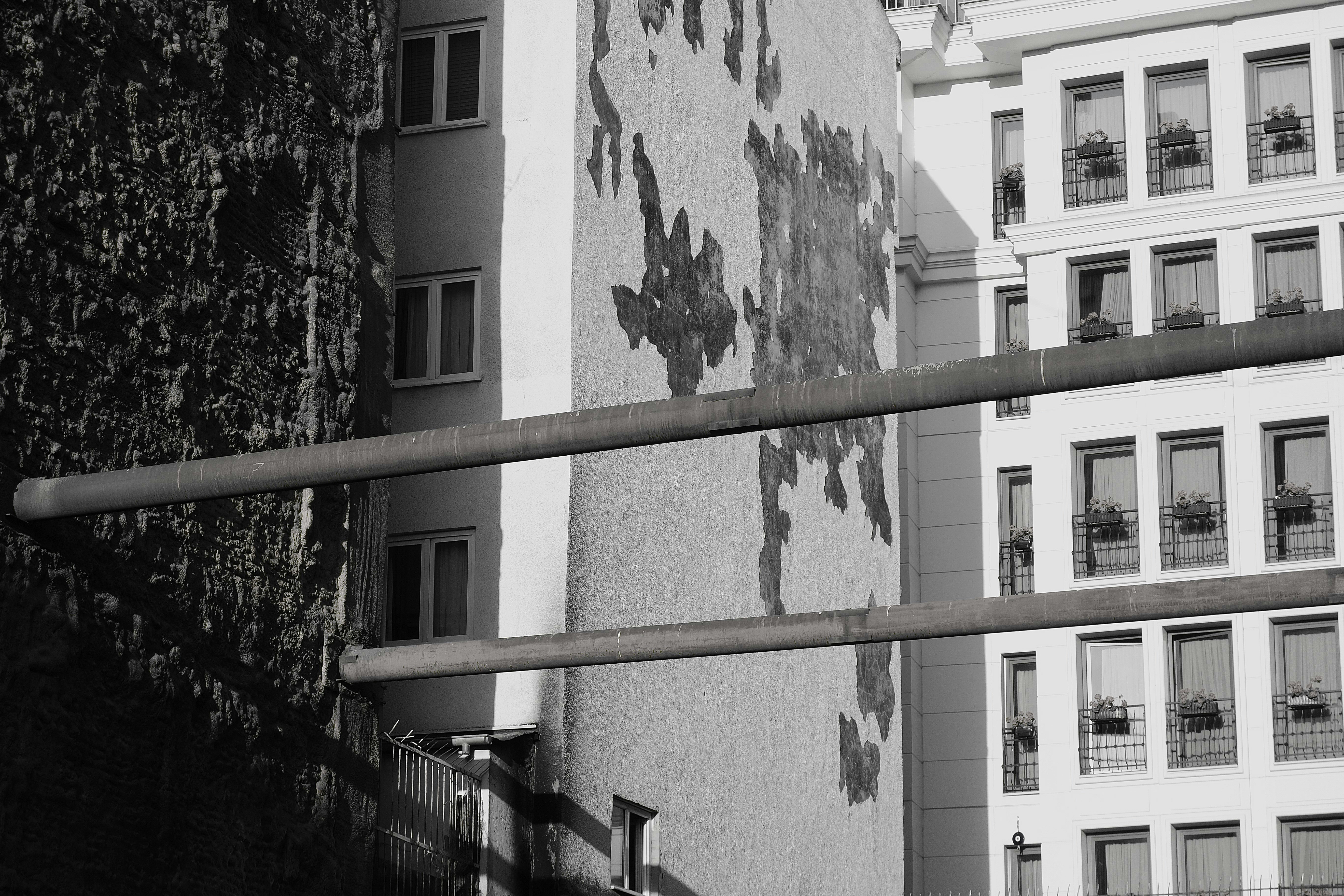Concrete Strata: A Dance of Shadows Across a Sunlit Facade