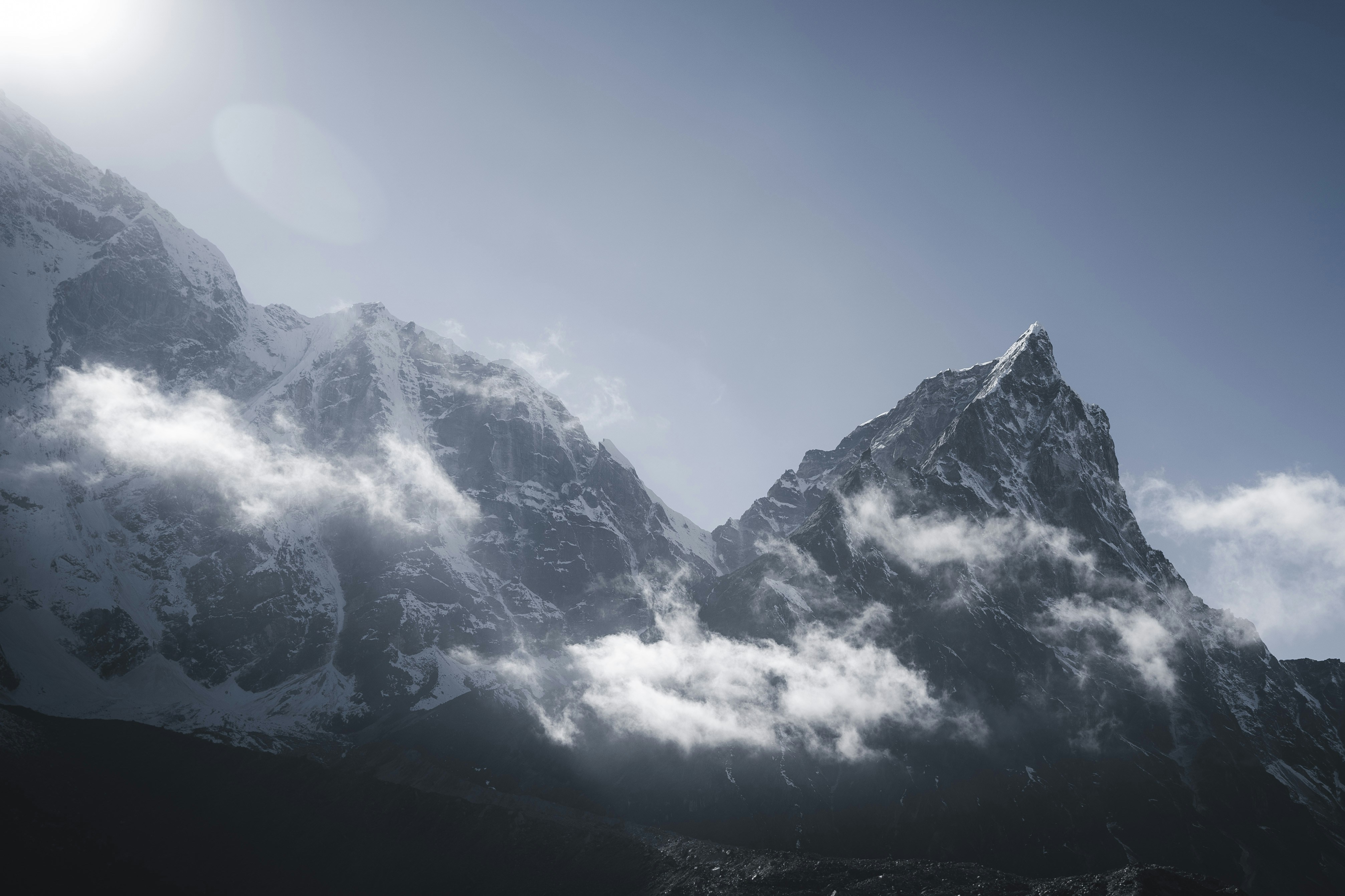 Apex Dawn: Snow-Capped Summit Under Clear Sky