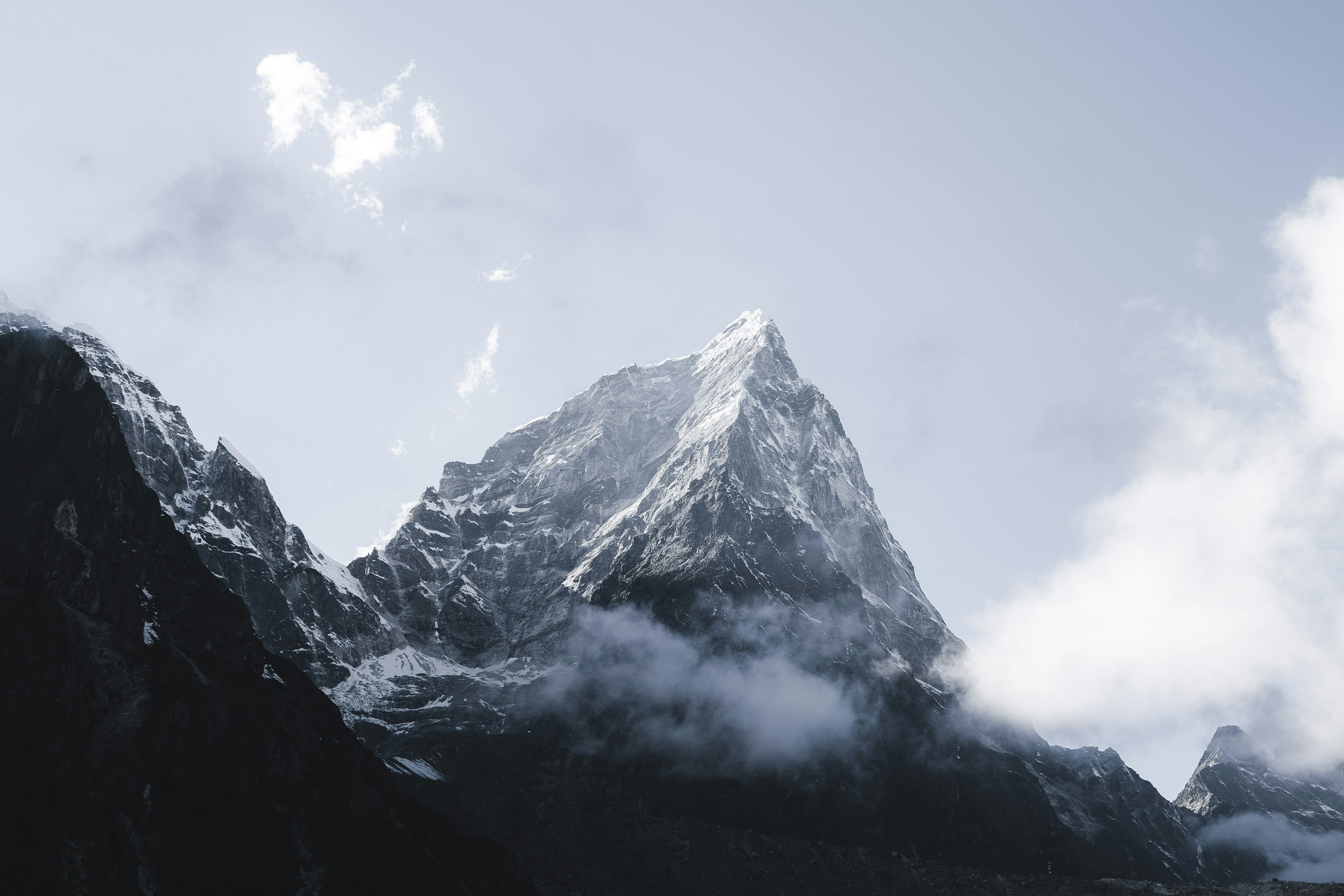 Peak Crowned by Clouds Over Dark Slopes