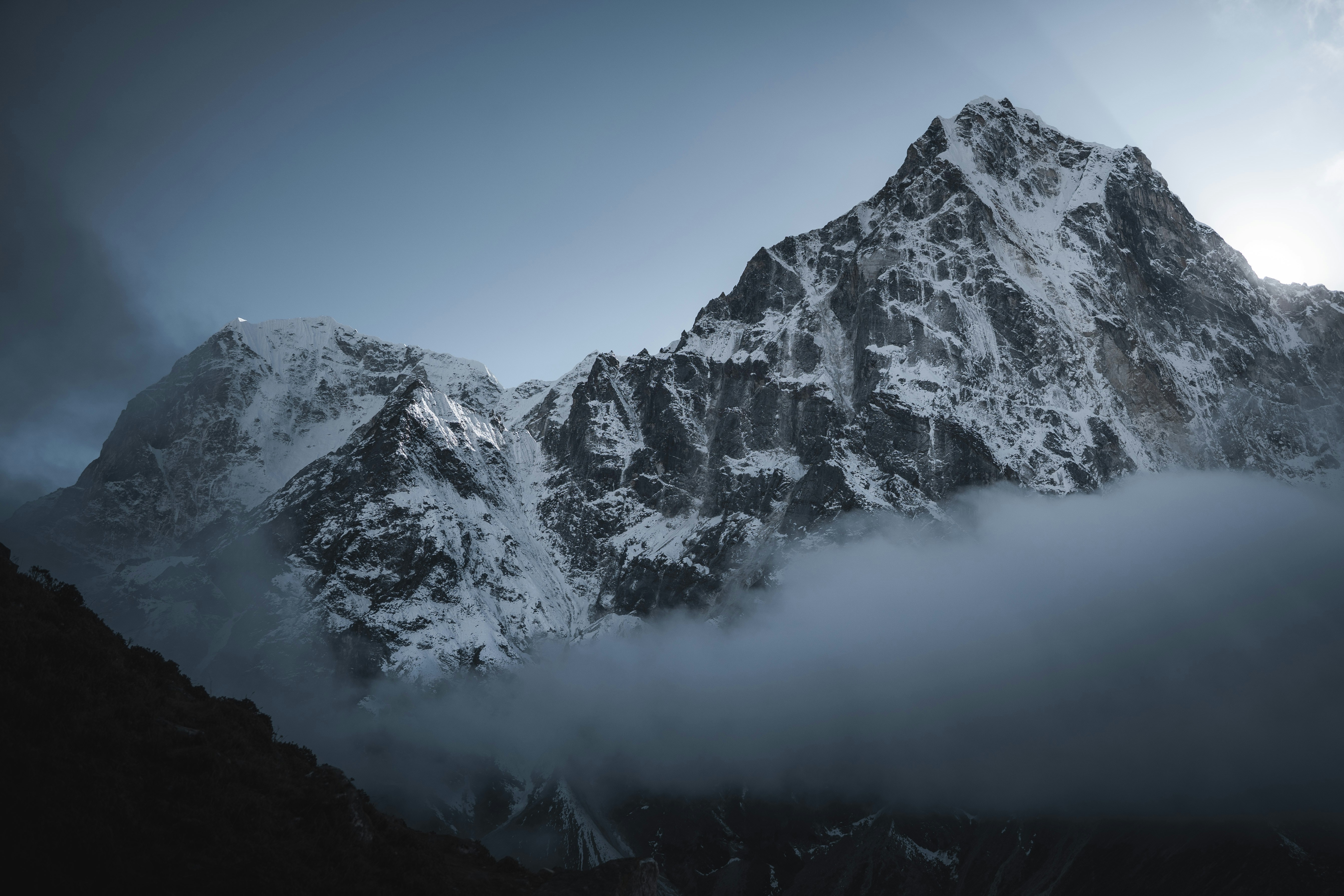 Apex Crowned by Snow: Summit Emerging Through Low-Cloud Veil