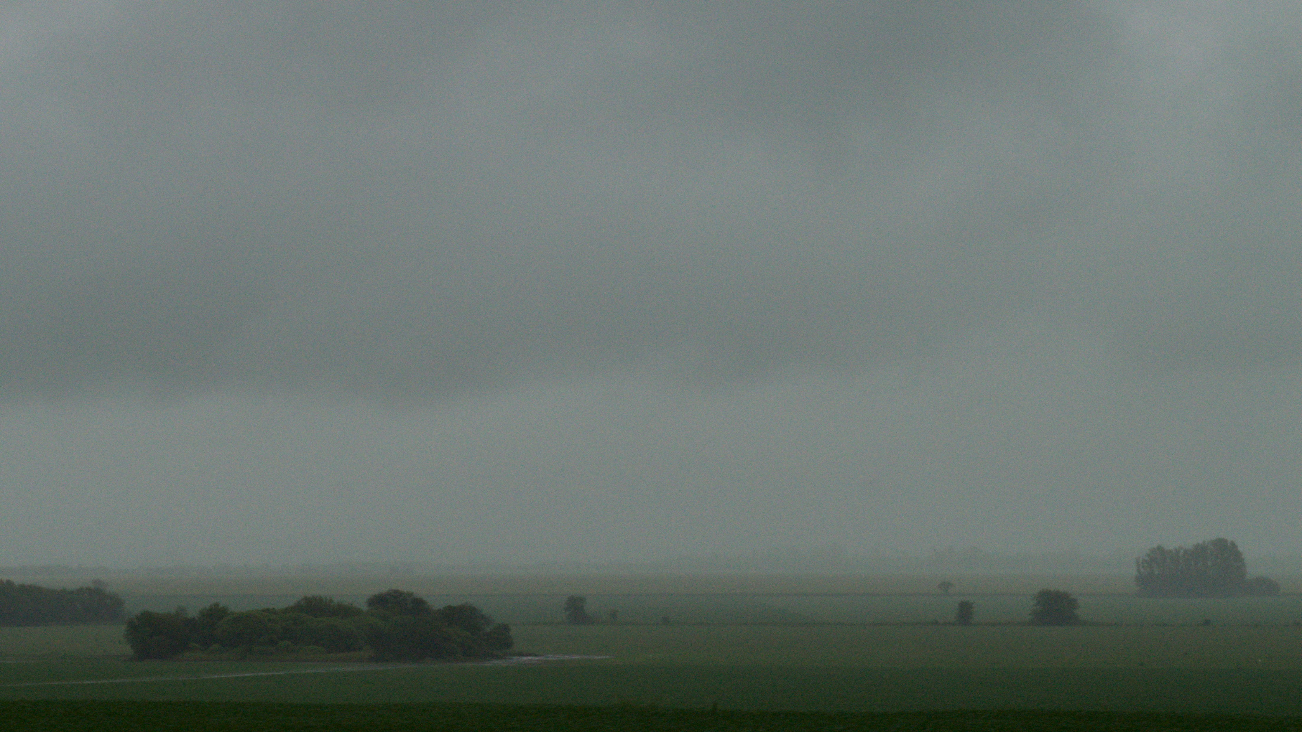 Low-Cloud Prairie Horizon Across Expansive Flats