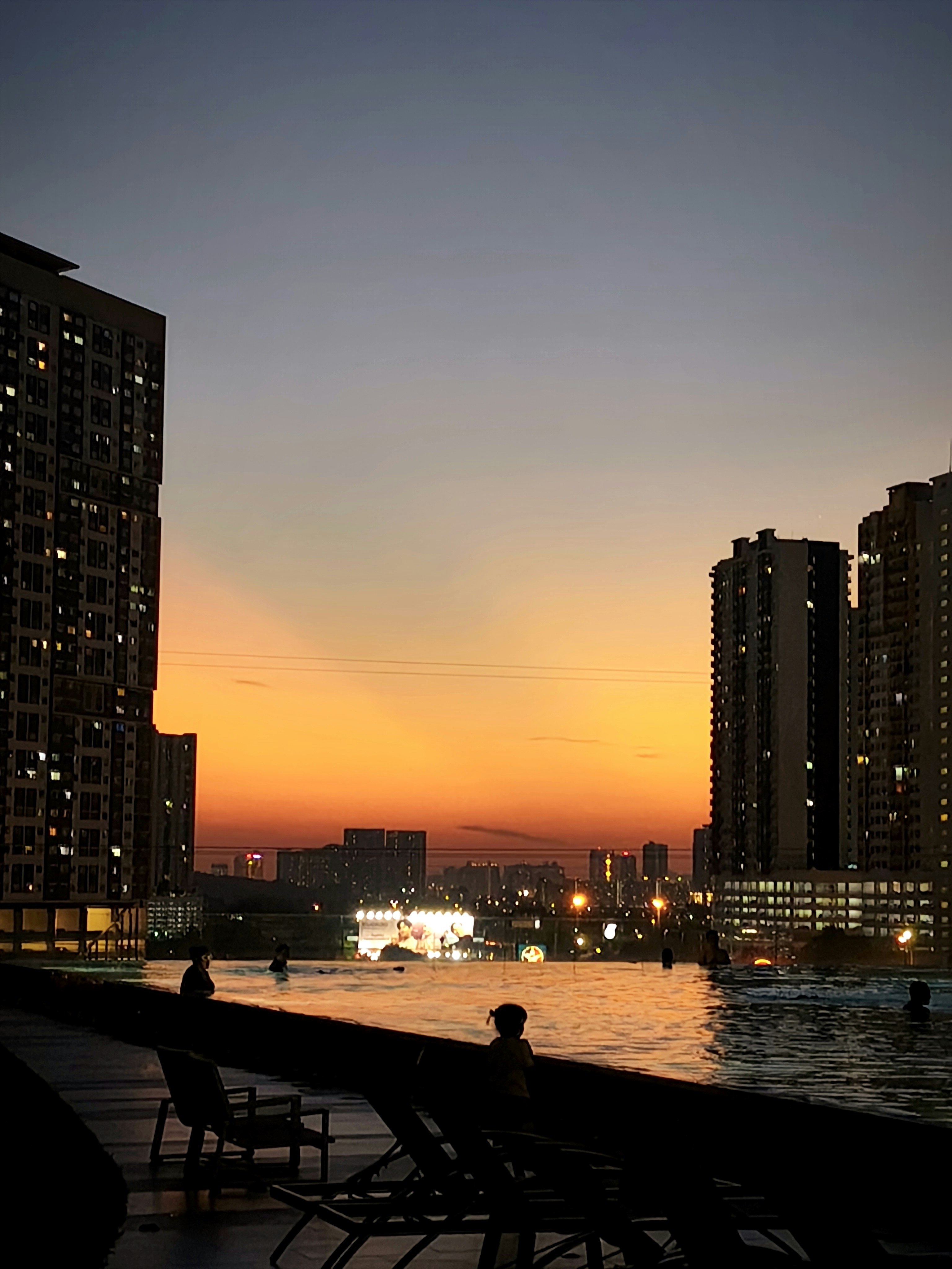 Sunset Over the Rooftop Pool: City Silhouette and Quiet Evening Light