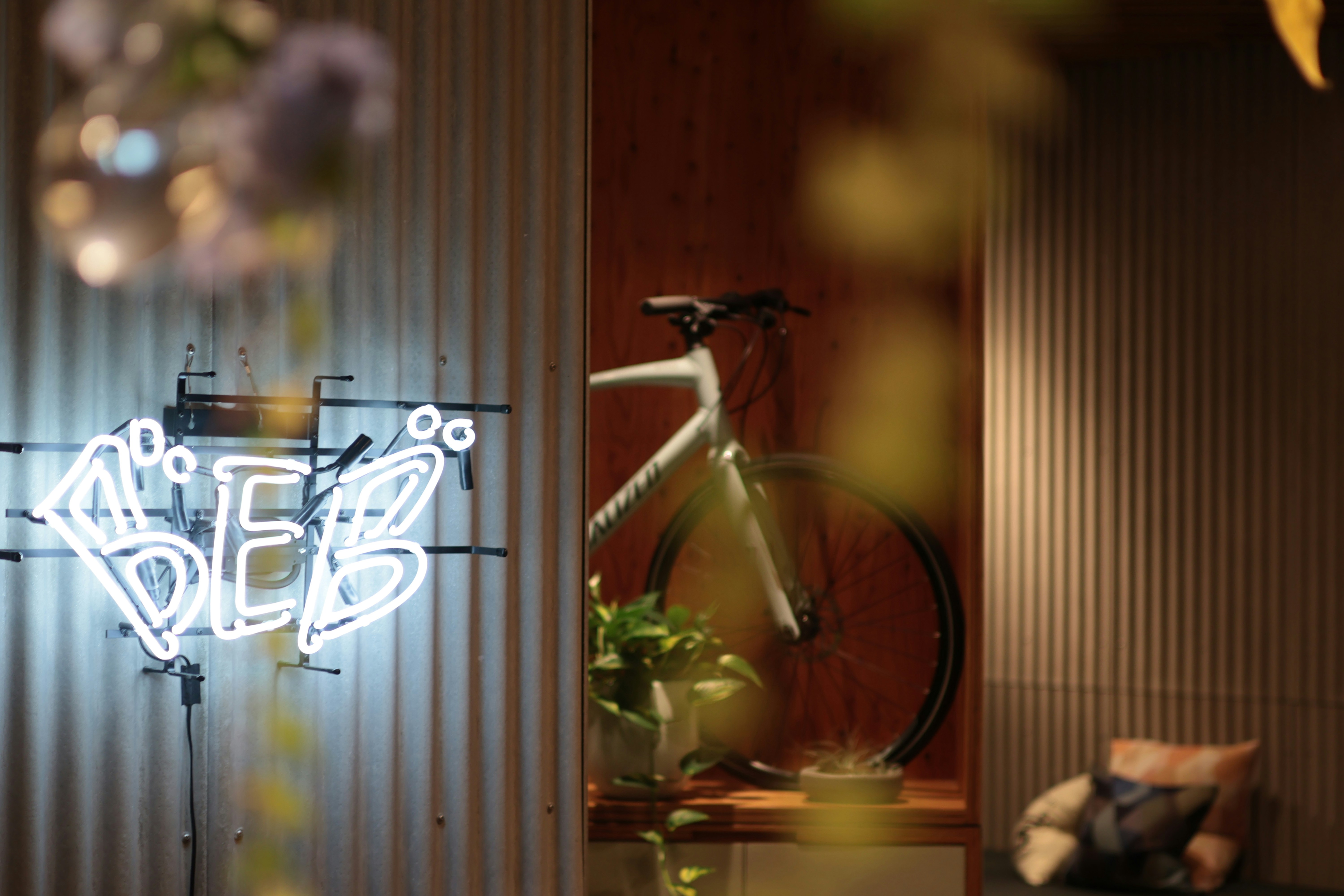 Neon Sign Glow Framing a Bicycle in an Urban Nook