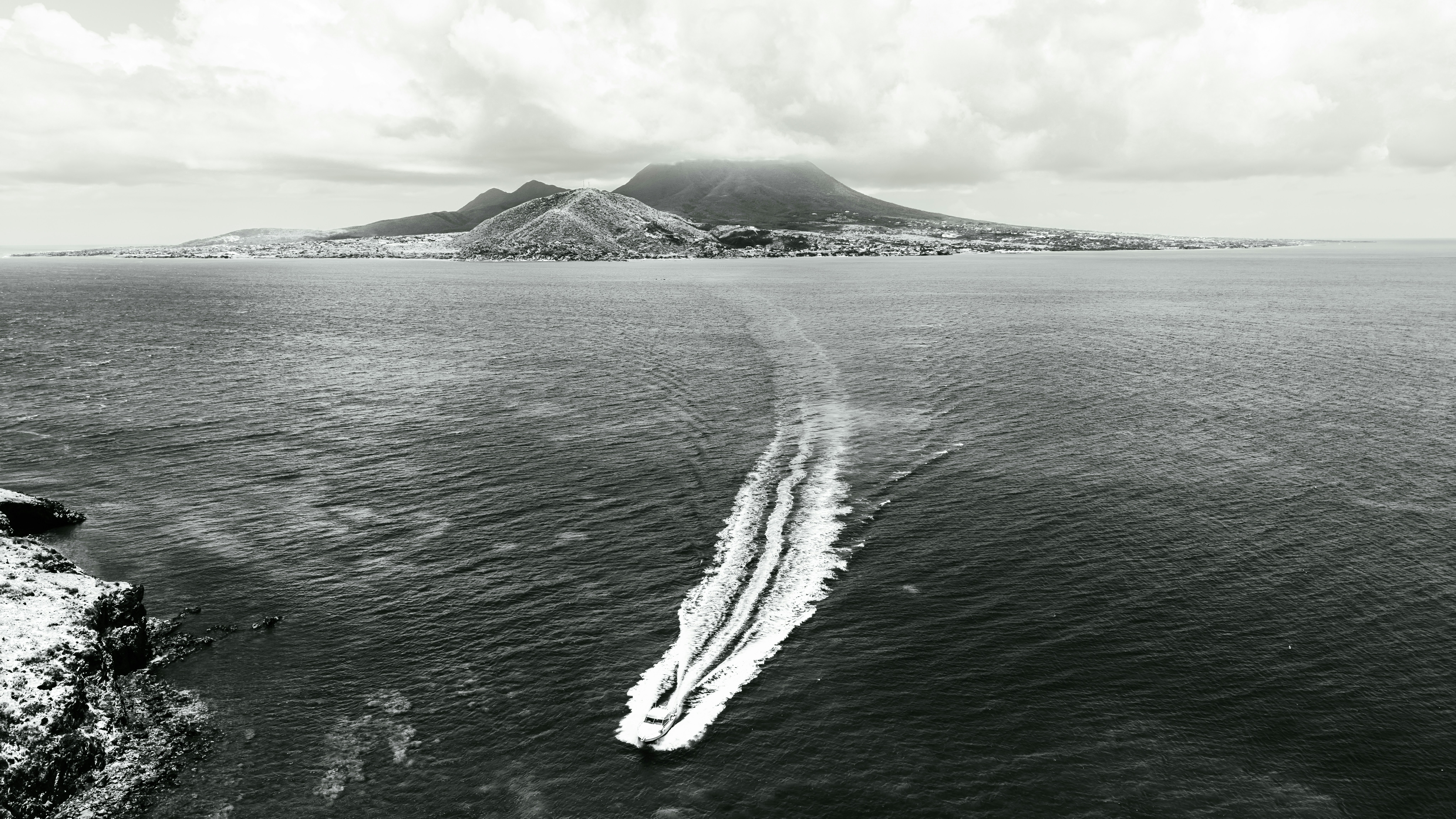 Wake carving a path to the distant island