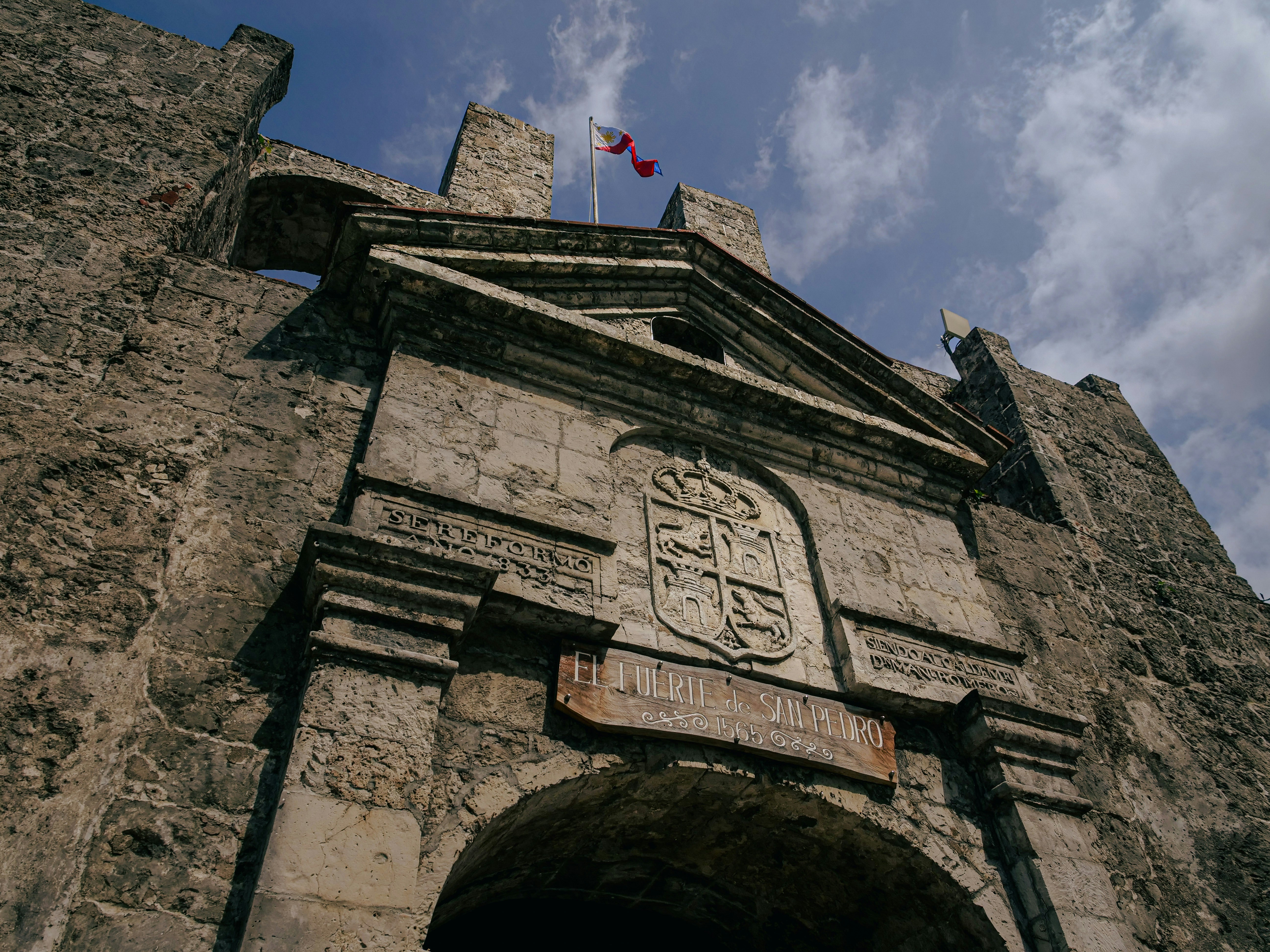 Stone Gatekeeper: A Weathered Fortress Pierced by the Sky
