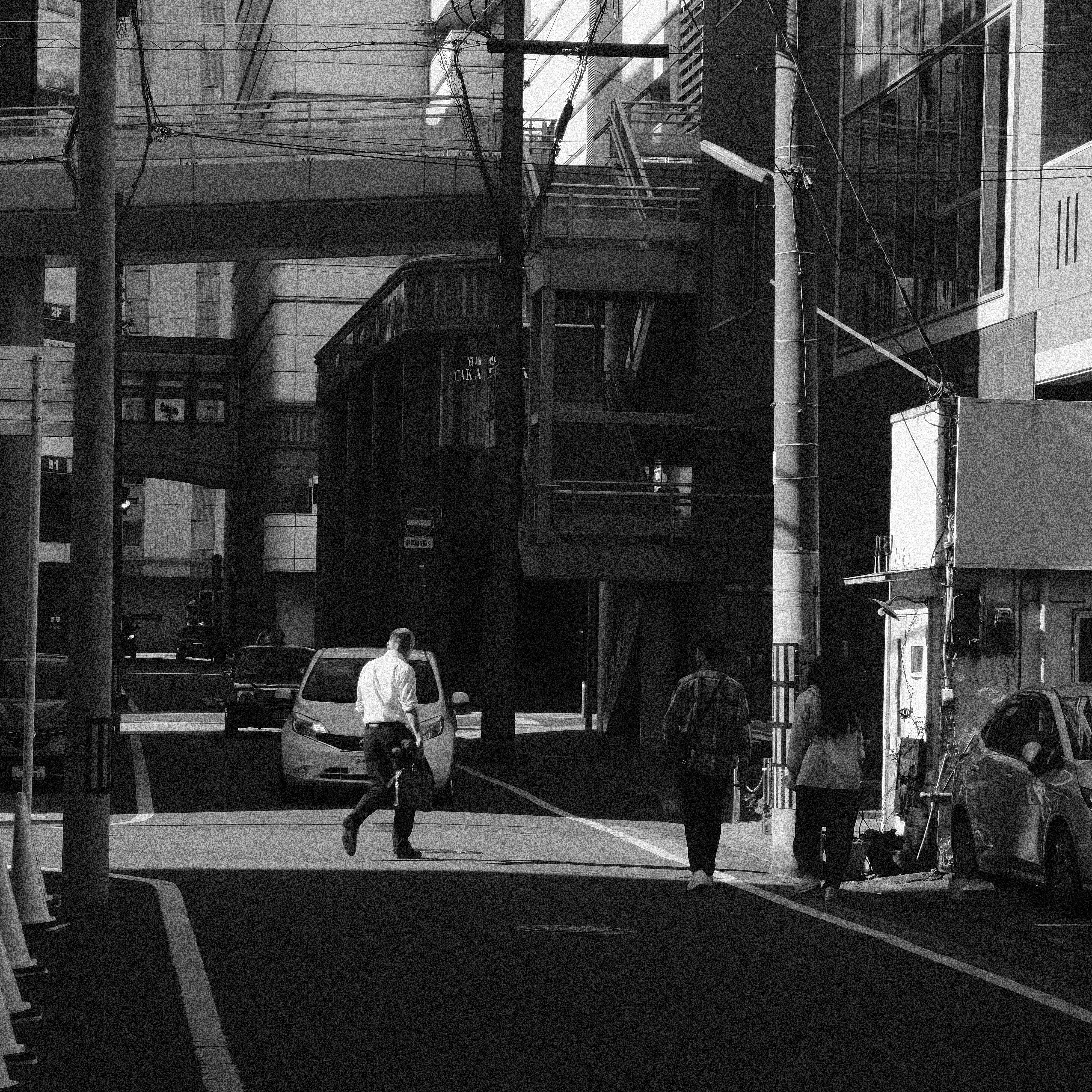 Crossing Shadows: City Street in Monochrome Motion