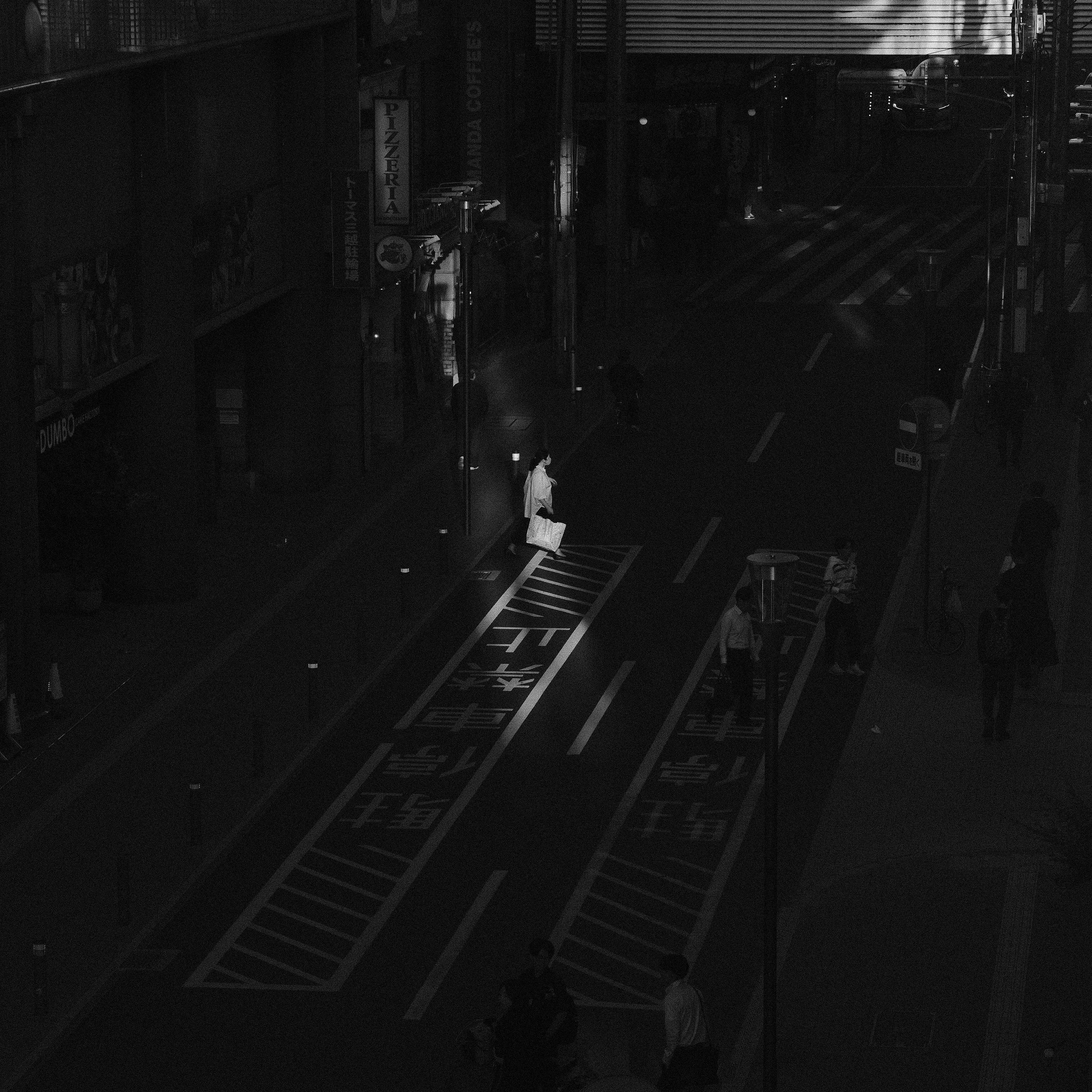 Midnight Crossing: A solitary figure on the striped crosswalk