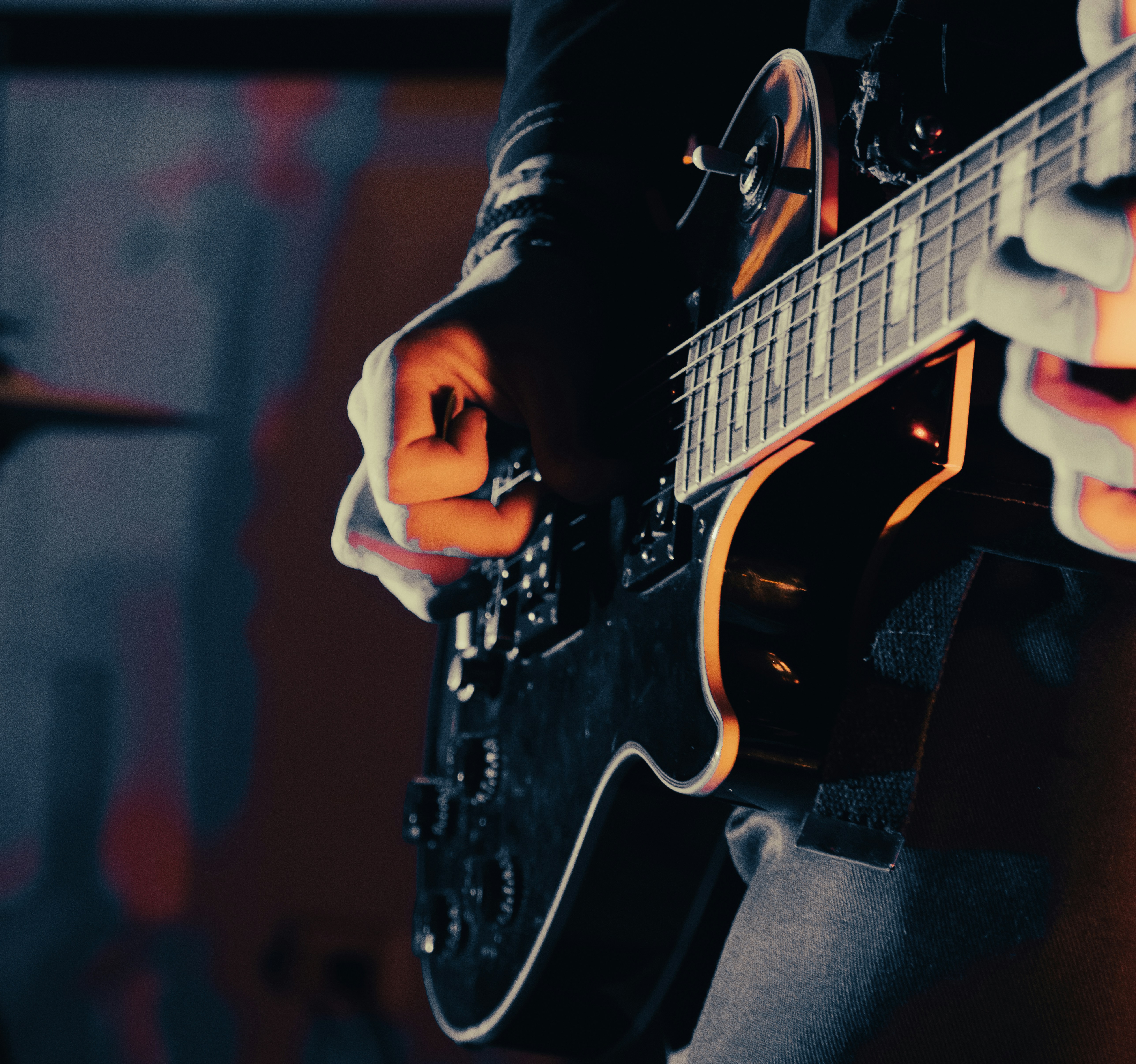 Strings in Focus: A Gritty Guitar Solo in Dim Stage Light