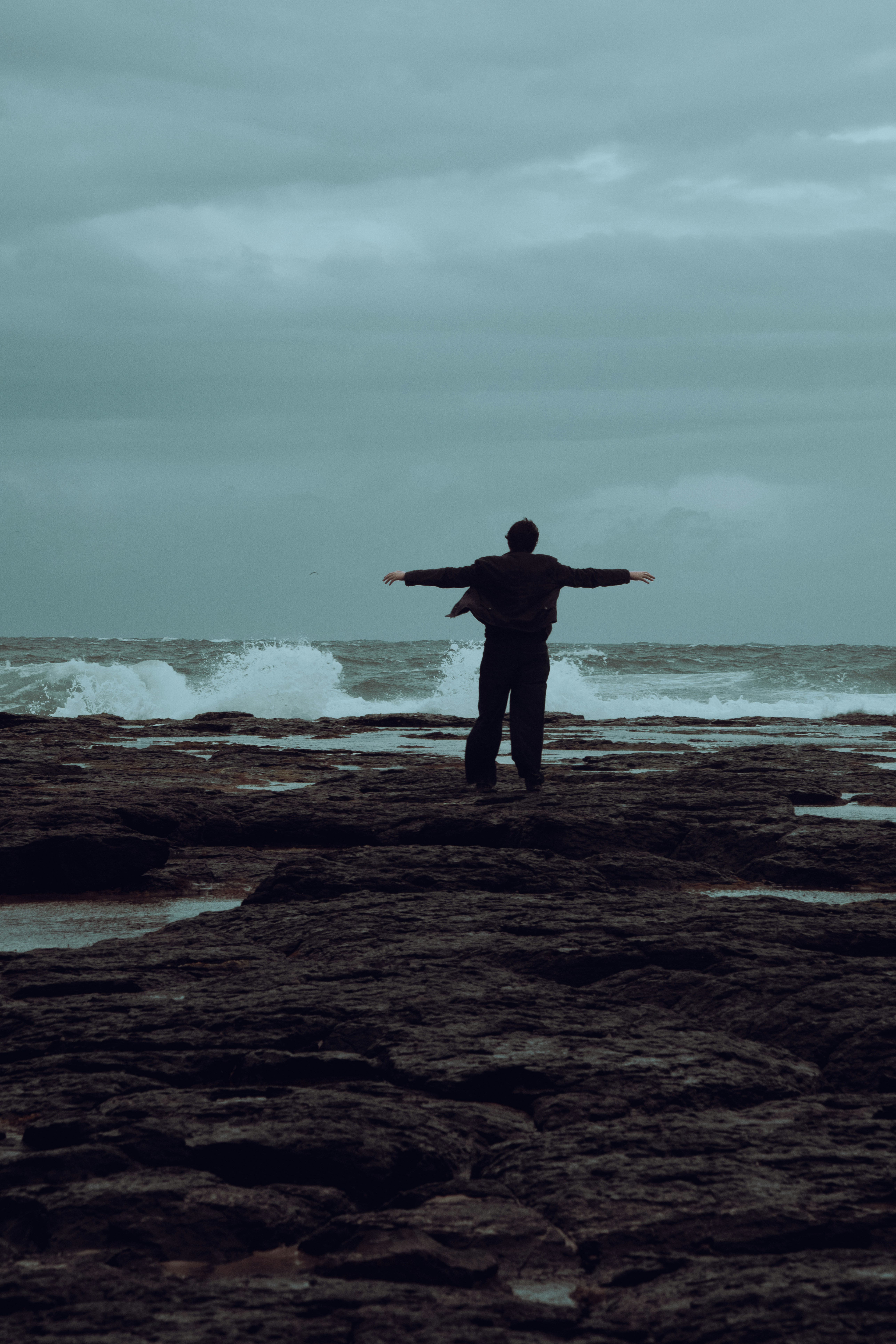 Open Arms on the Edge of the Sea