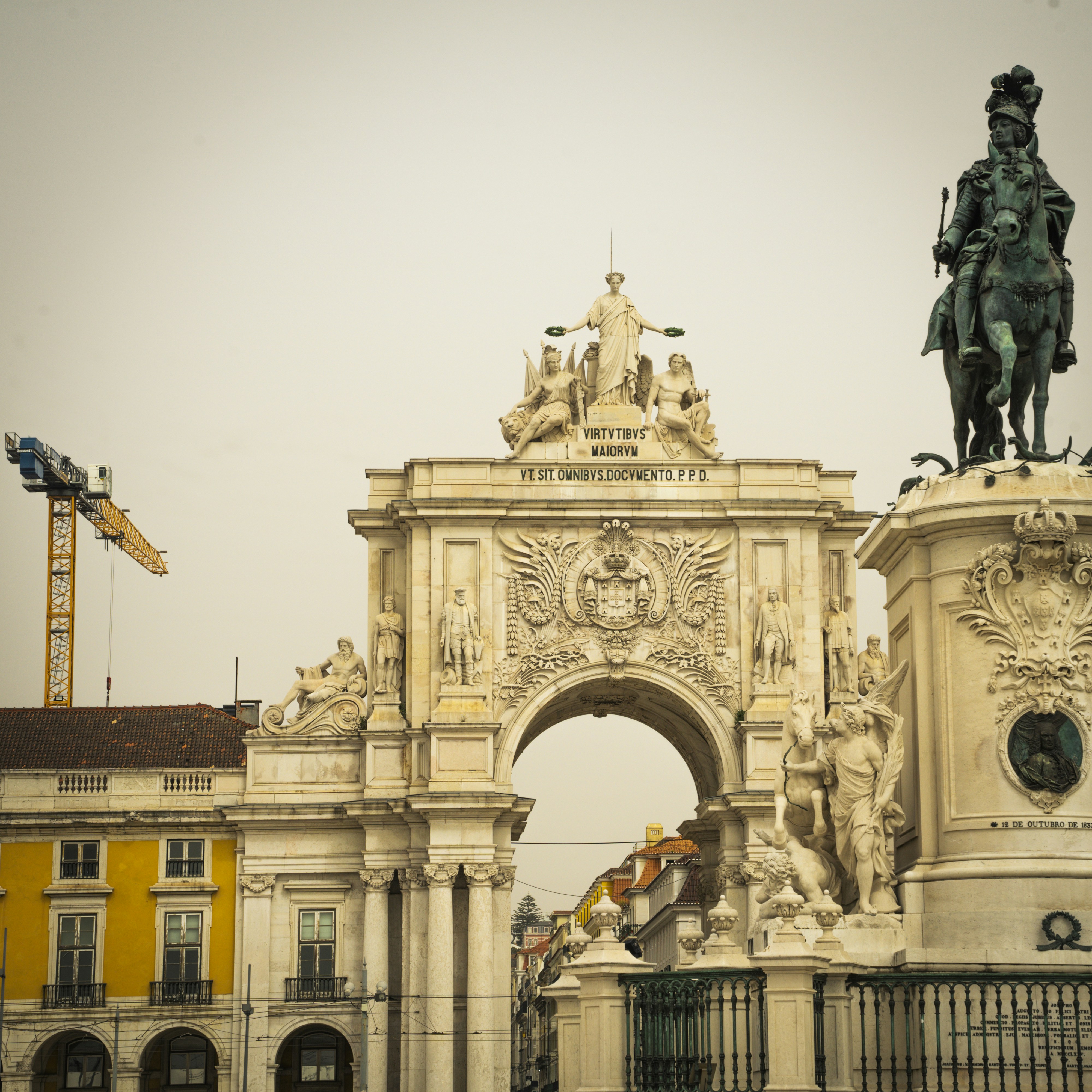 The Arch of Triumph: A monument of stone and statue under a pale sky