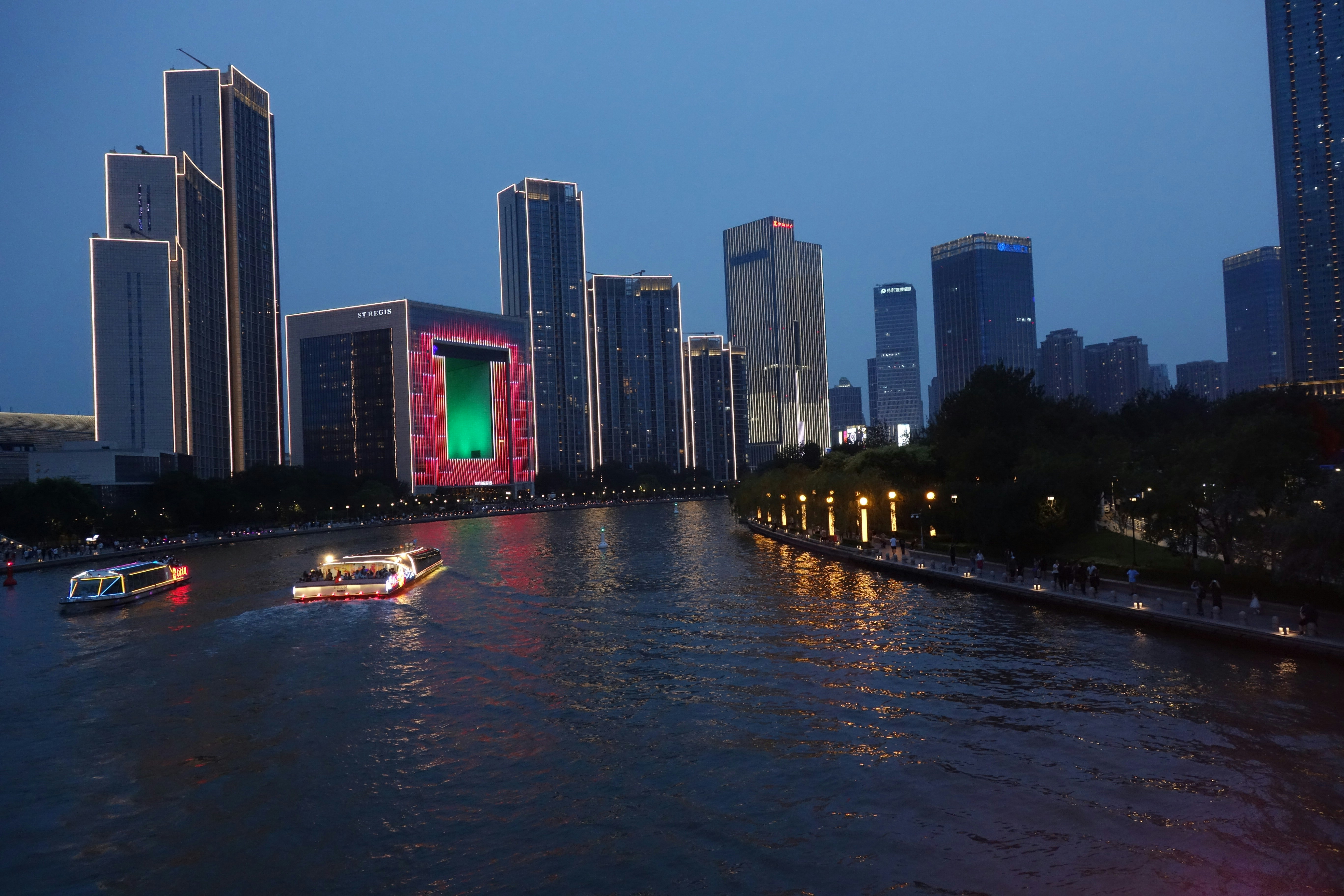 Neon Facade Over the River: A Modern Skyline at Dusk