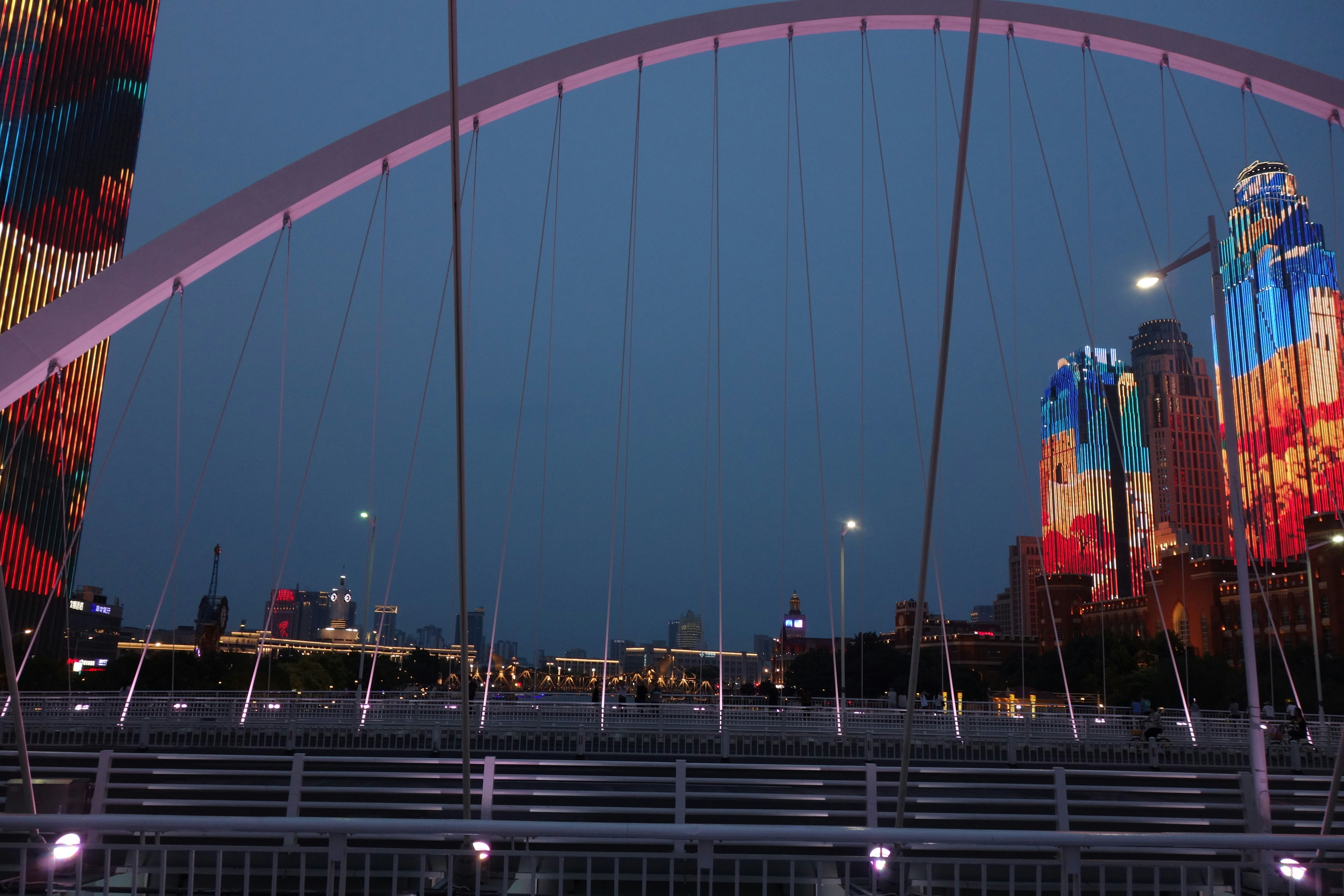 Illuminated Arch Over the River: Neon City Reflections