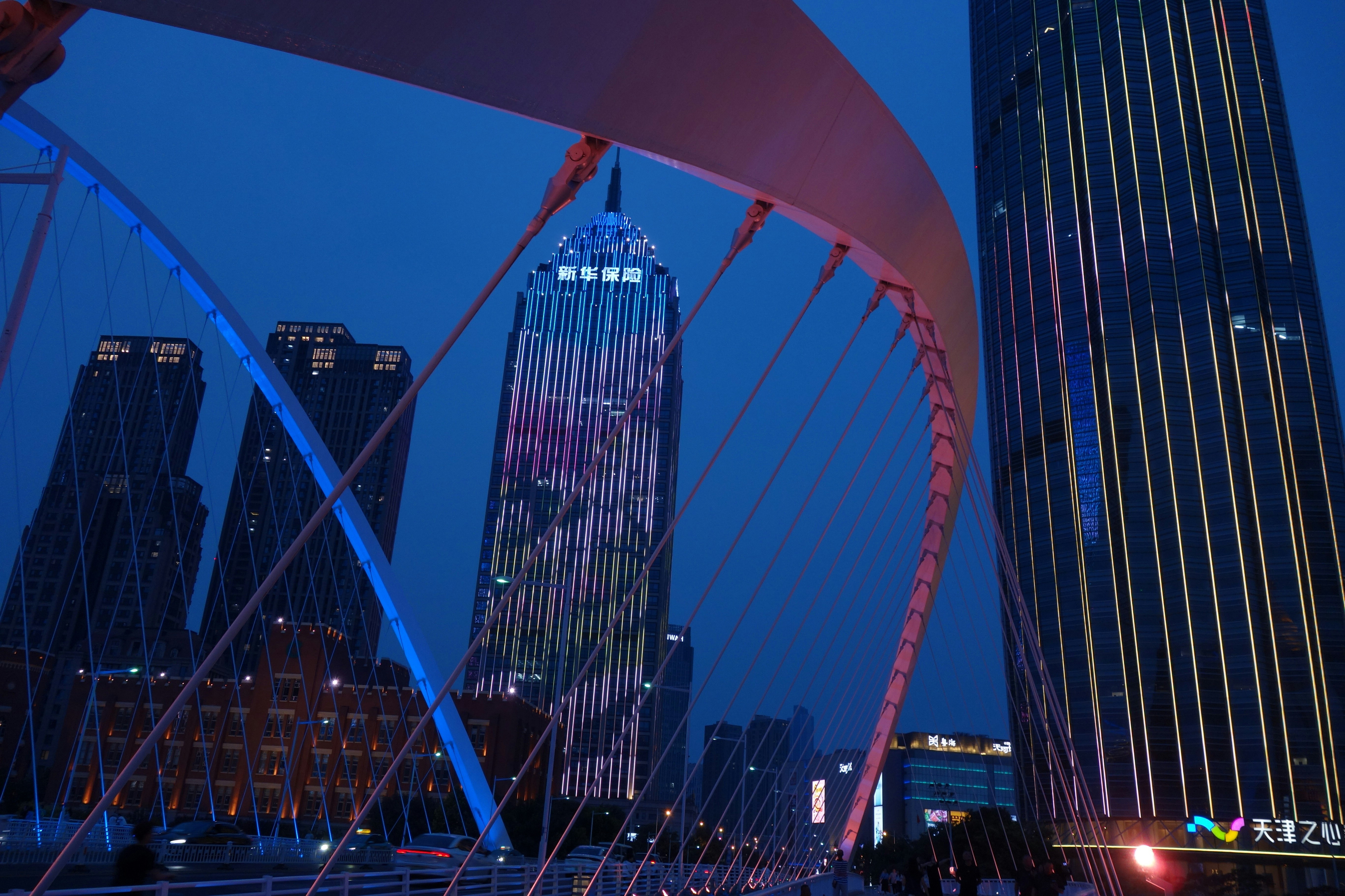 Blue Hour Arches Over a Neon Skyline