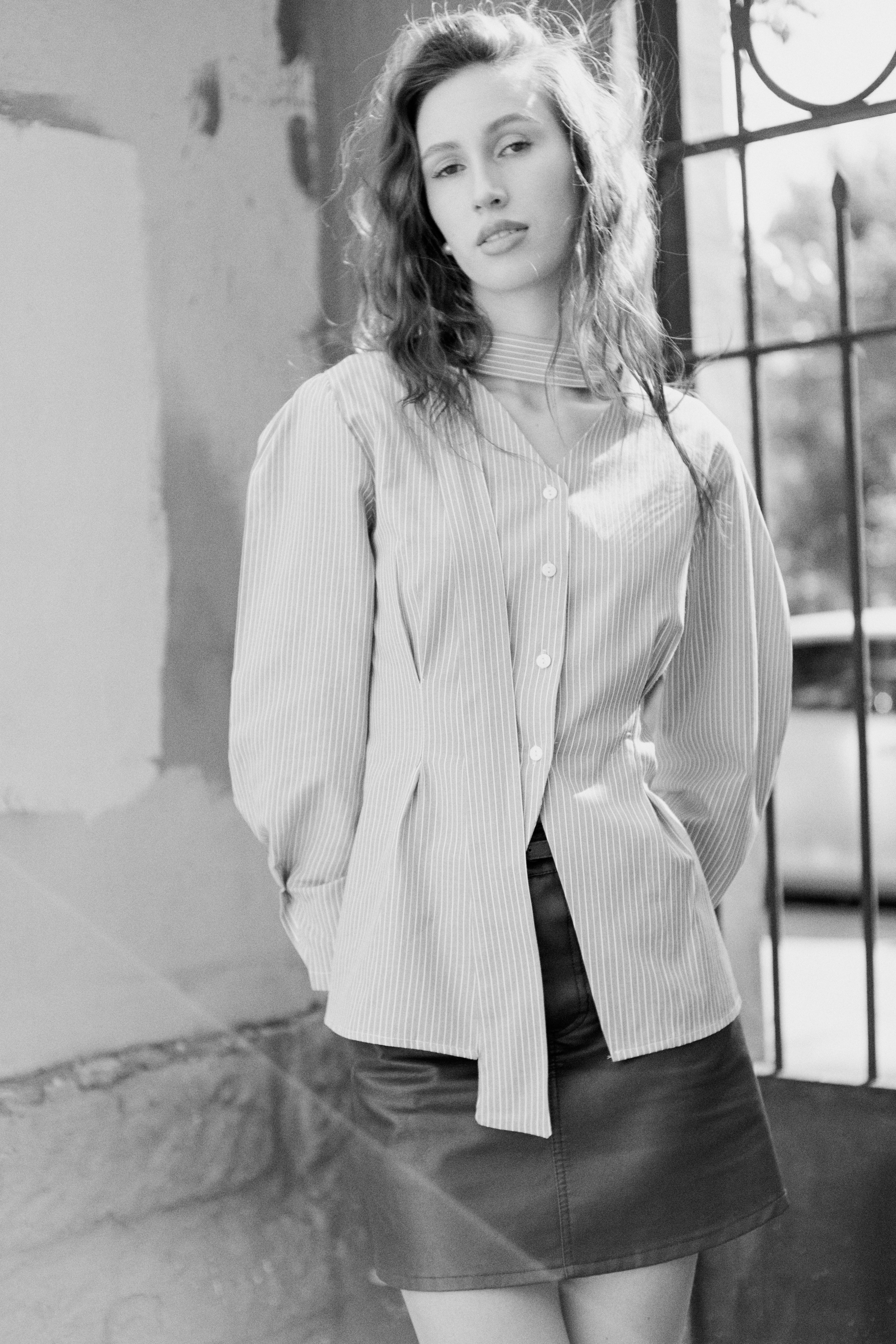Portrait in Striped Shirt by the Gate