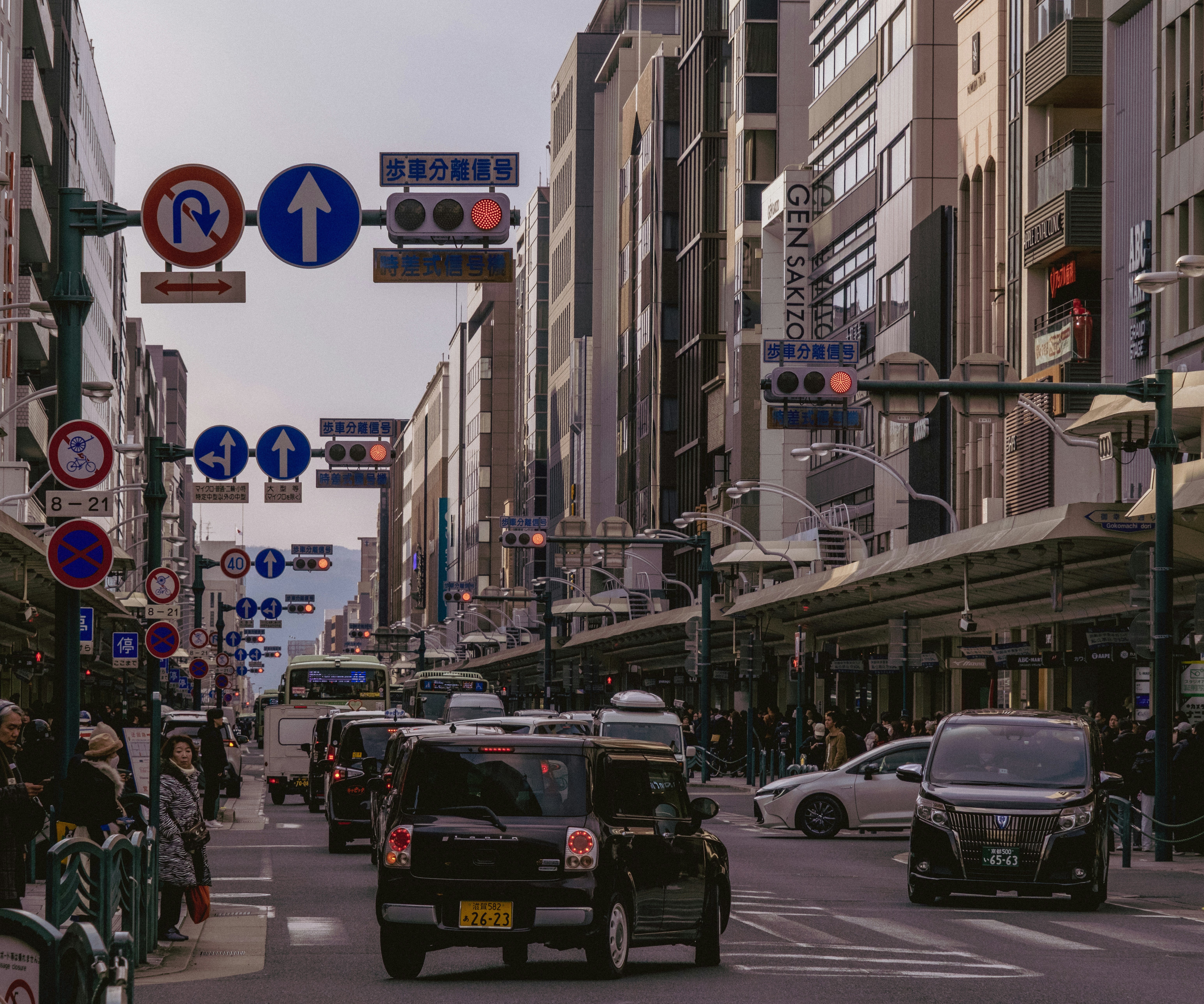 Urban Boulevard at Dusk: A Busier Crossroads Framed by Signage