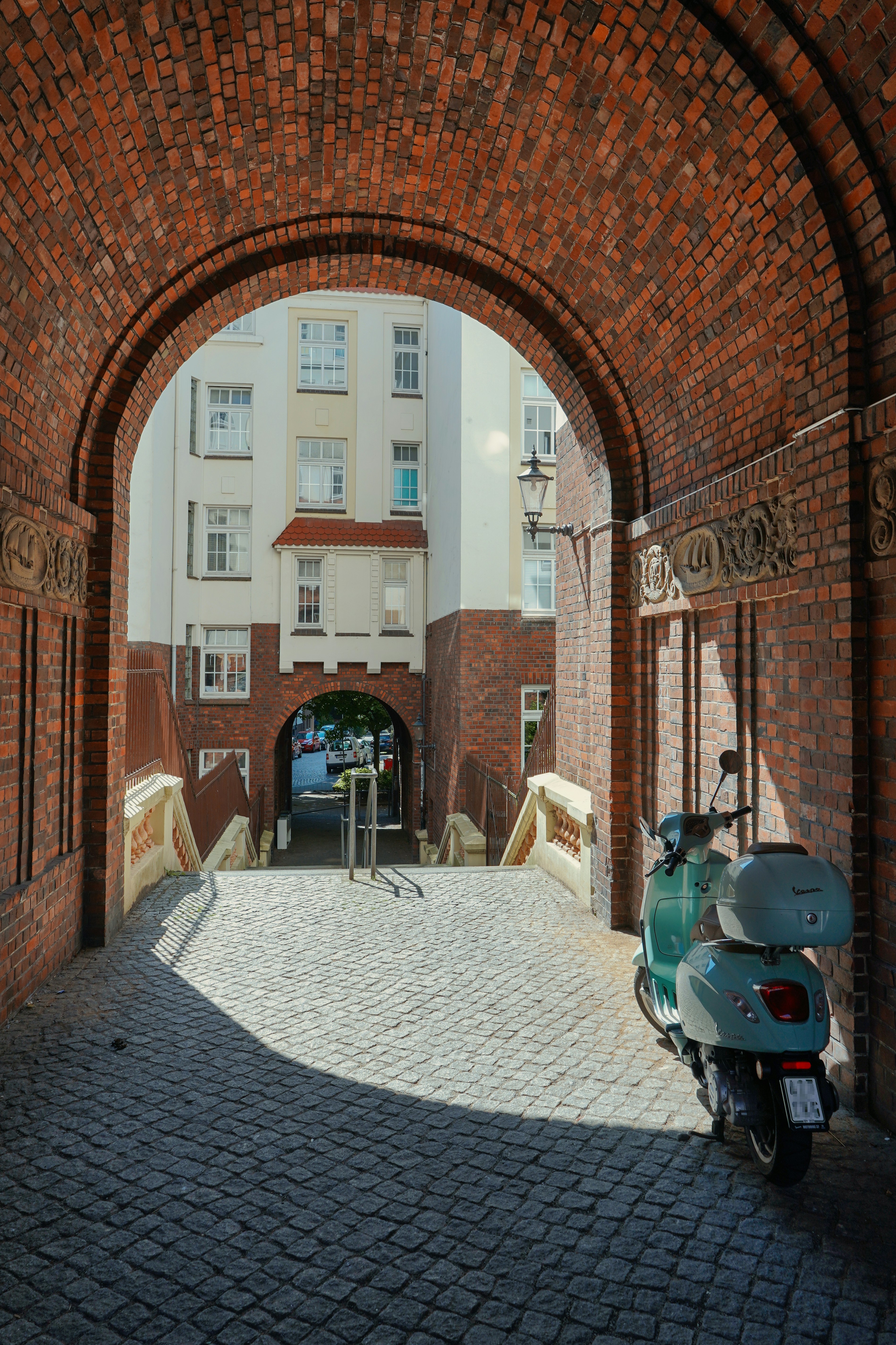 Brick Archway to a Sunlit Courtyard: A Quiet Link Between Worlds