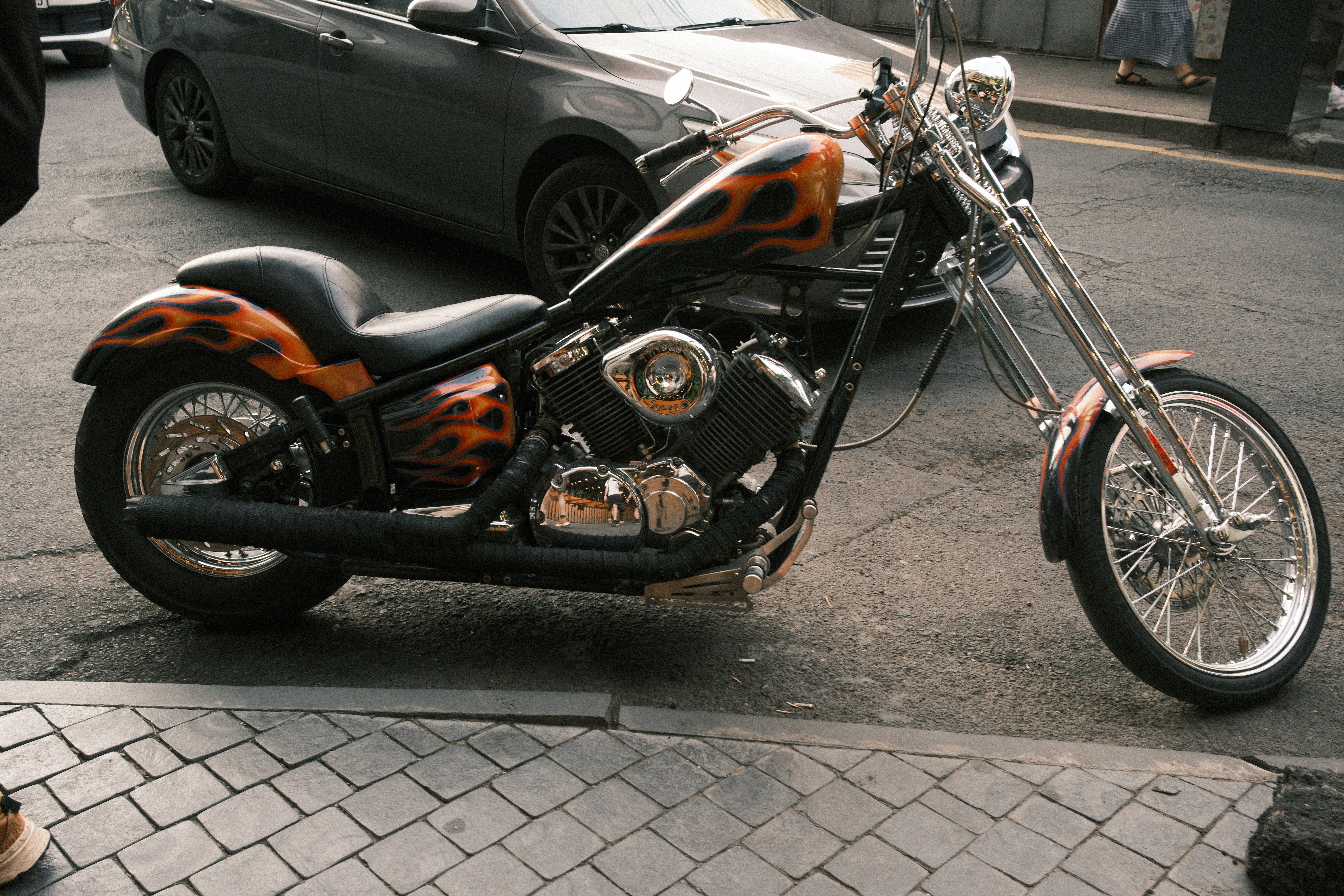 Chrome Street Oracle: Flame-Carved Motorcycle Under City Gaze