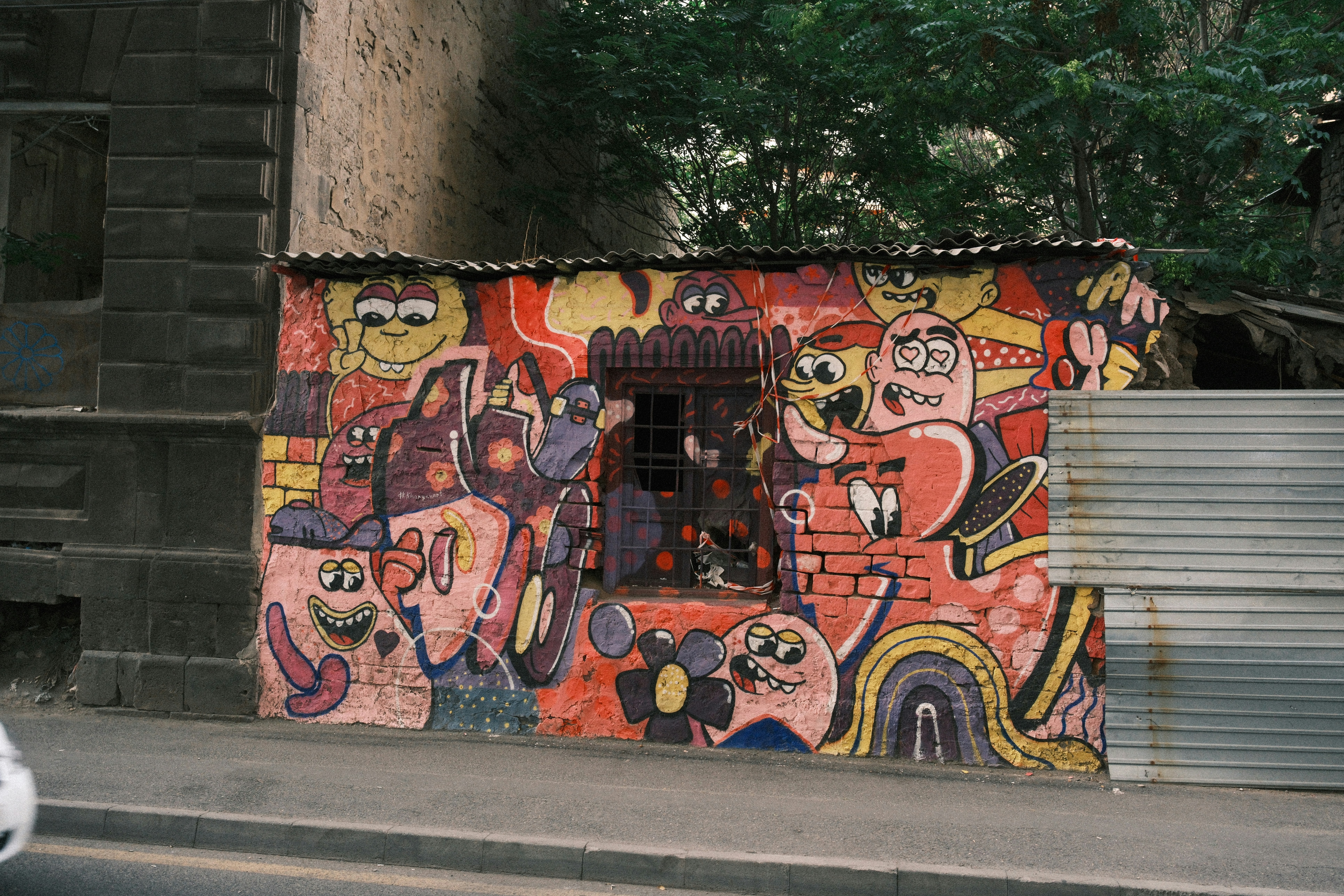 Graffiti Portraits of Urban Giants on a Weathered Wall