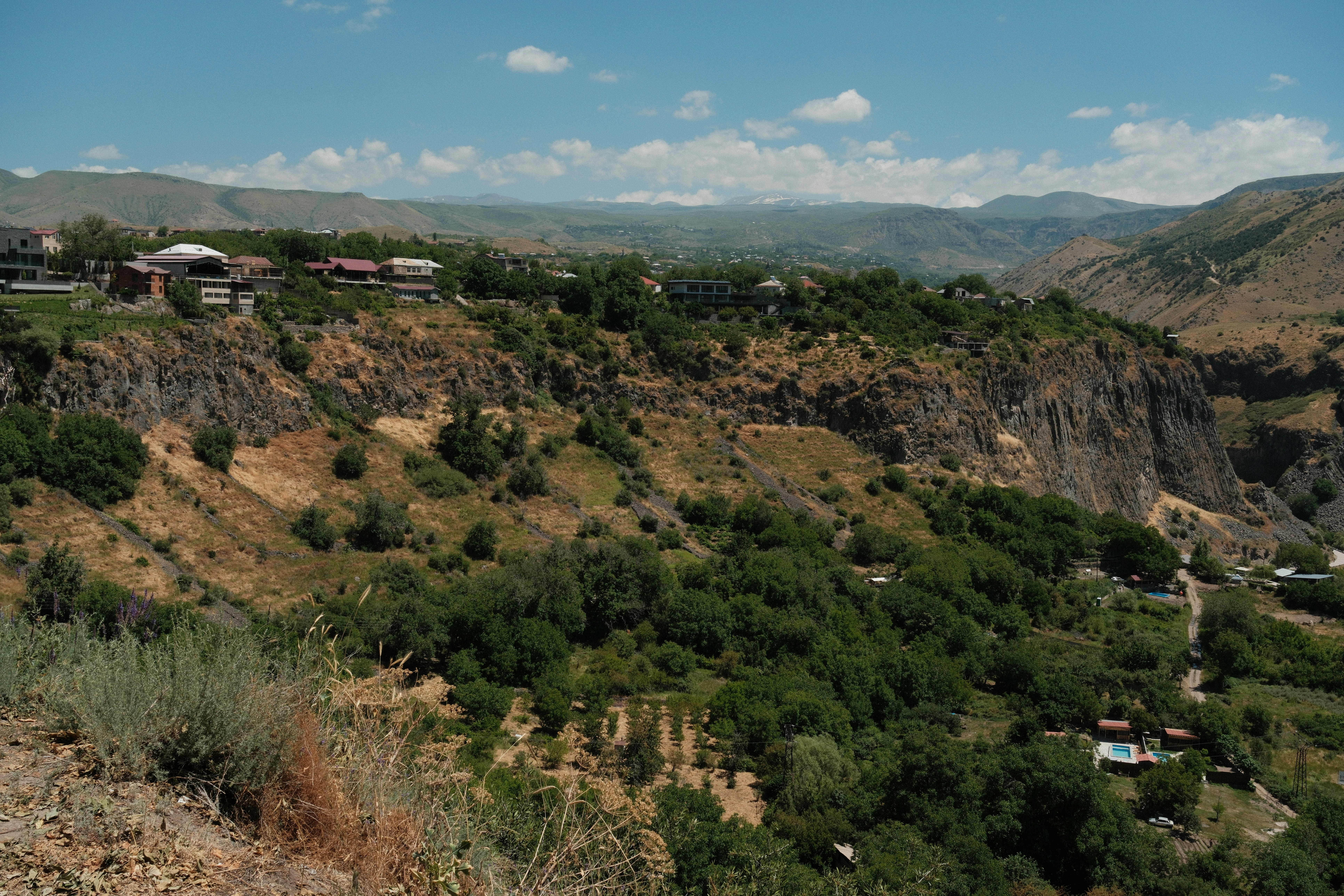 Terraced cliffs and sunlit villages cradle a valley panorama