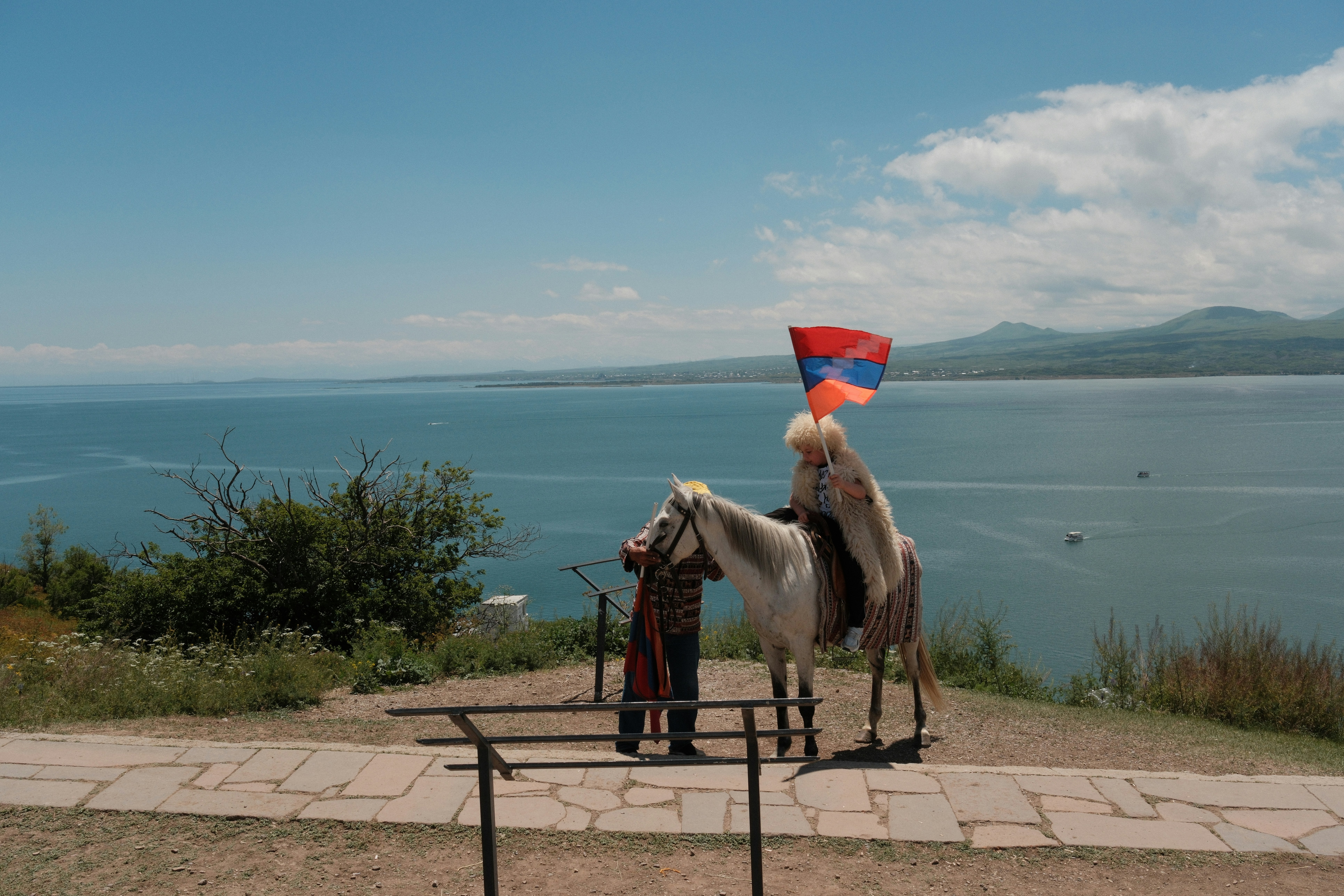 Flag Bearer and White Horse at a Coastal Vista