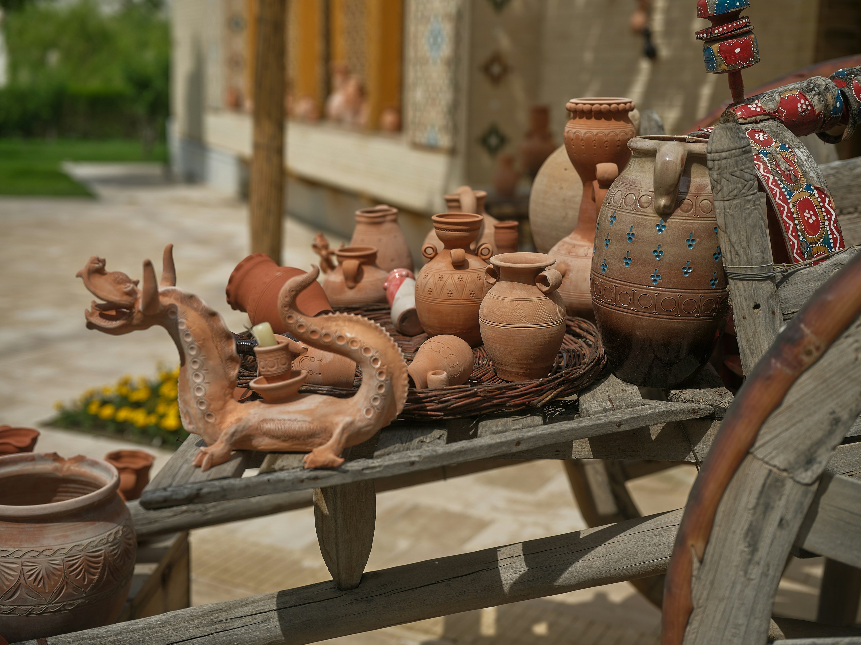 Terracotta Pottery Parade: Handcrafted Vessels on a Wood Cart
