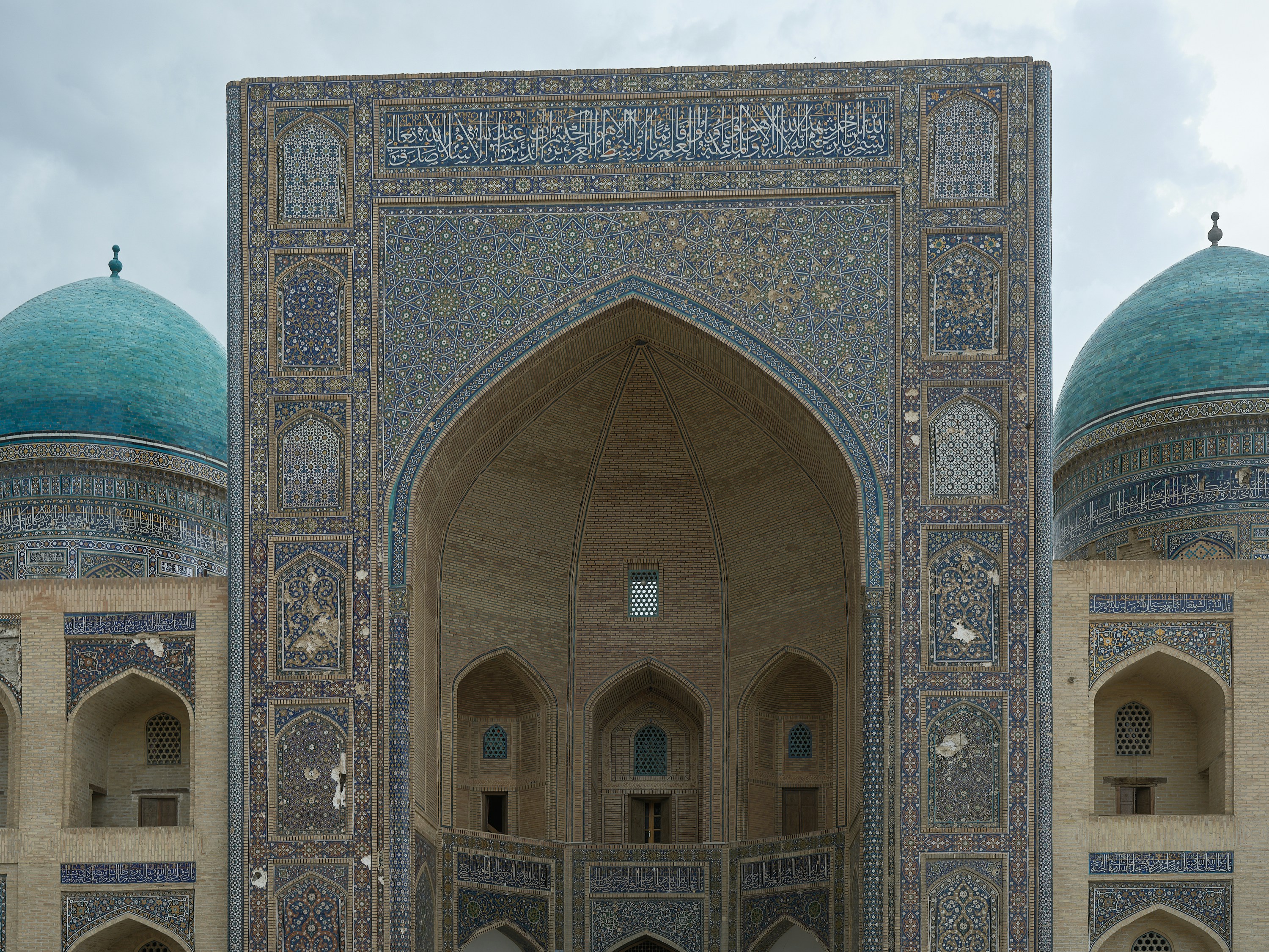 Ornate Central Archway Framing Two Turquoise Domes