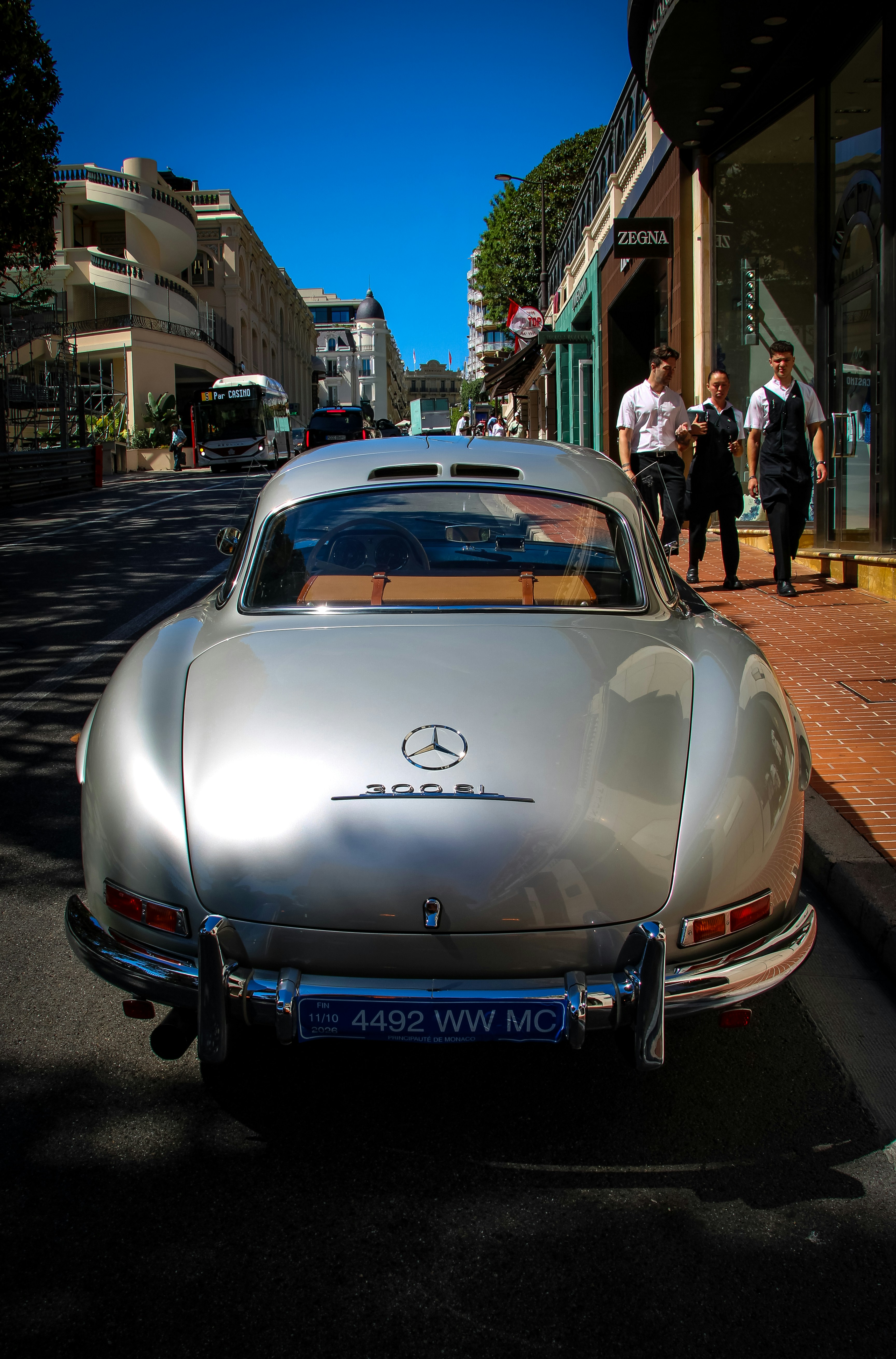 Timeless Silver: The Rear of a Classic Mercedes Anchors a Sunlit Street