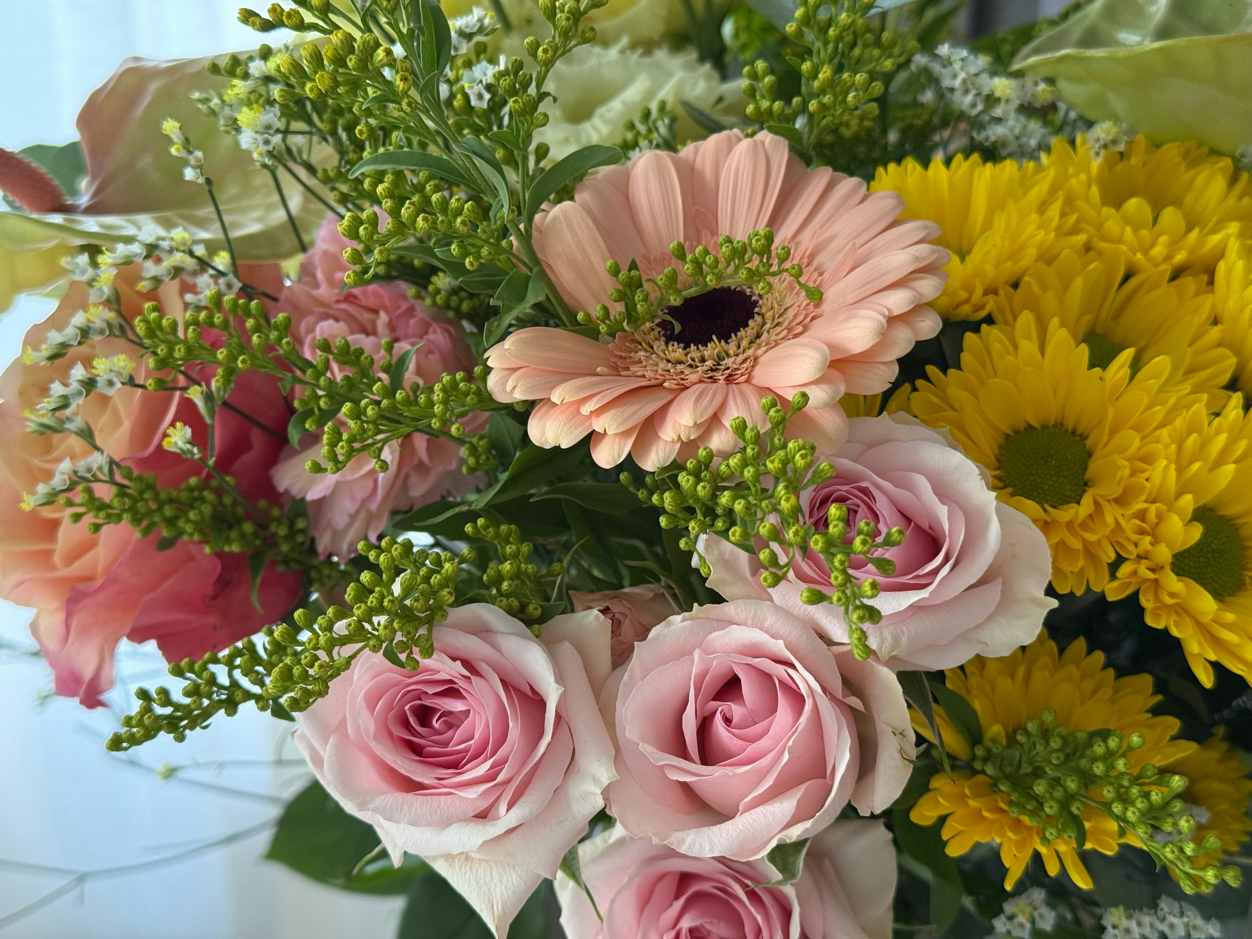 Soft Pink Roses Amid Bright Yellow Chrysanthemums