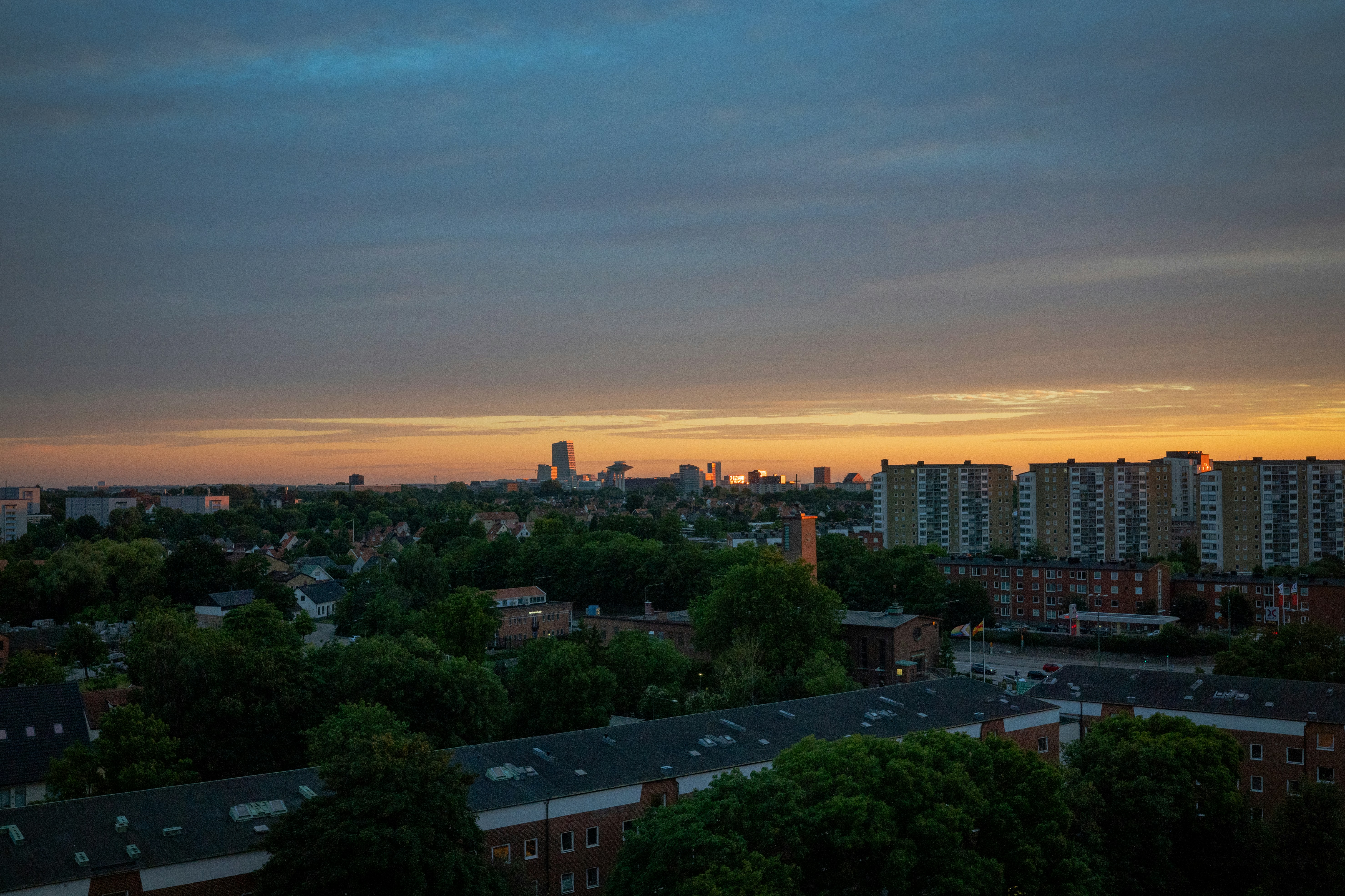Distant City Skyline at Dusk over Quiet Rooftops