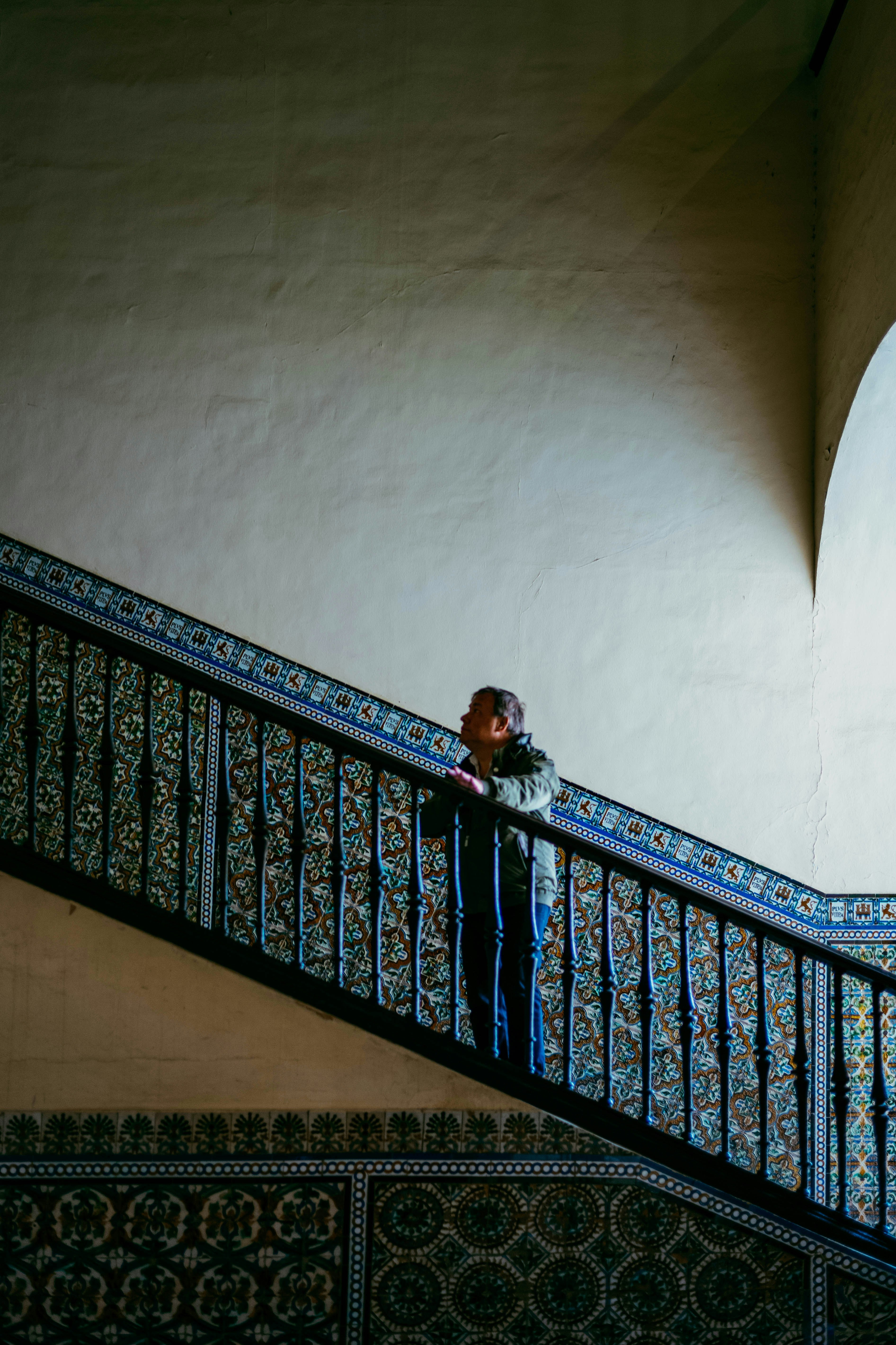 Rising Above the Banister: A Quiet Moment on Tile and Rail