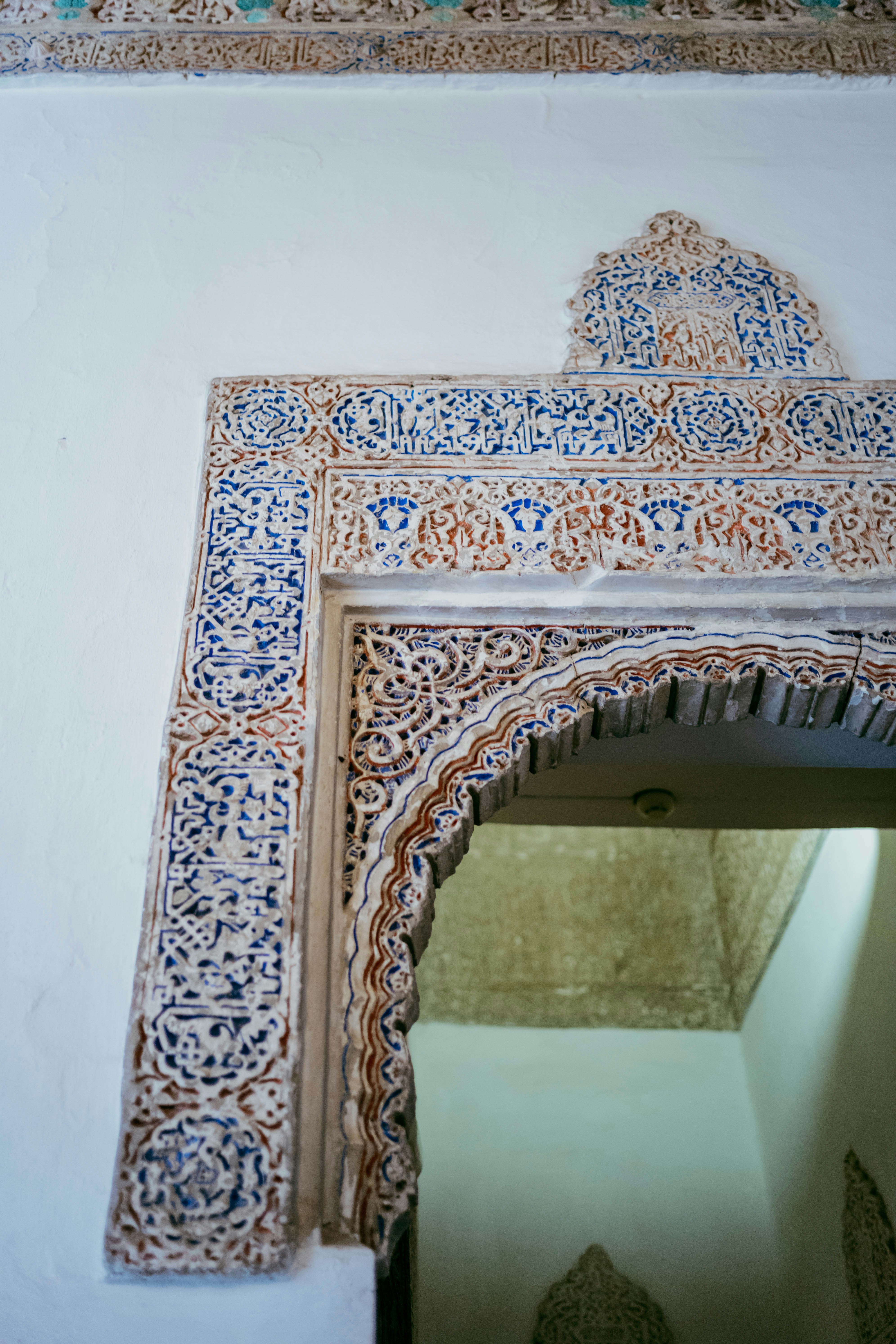 Ornate archway with intricate islamic patterns and calligraphy.