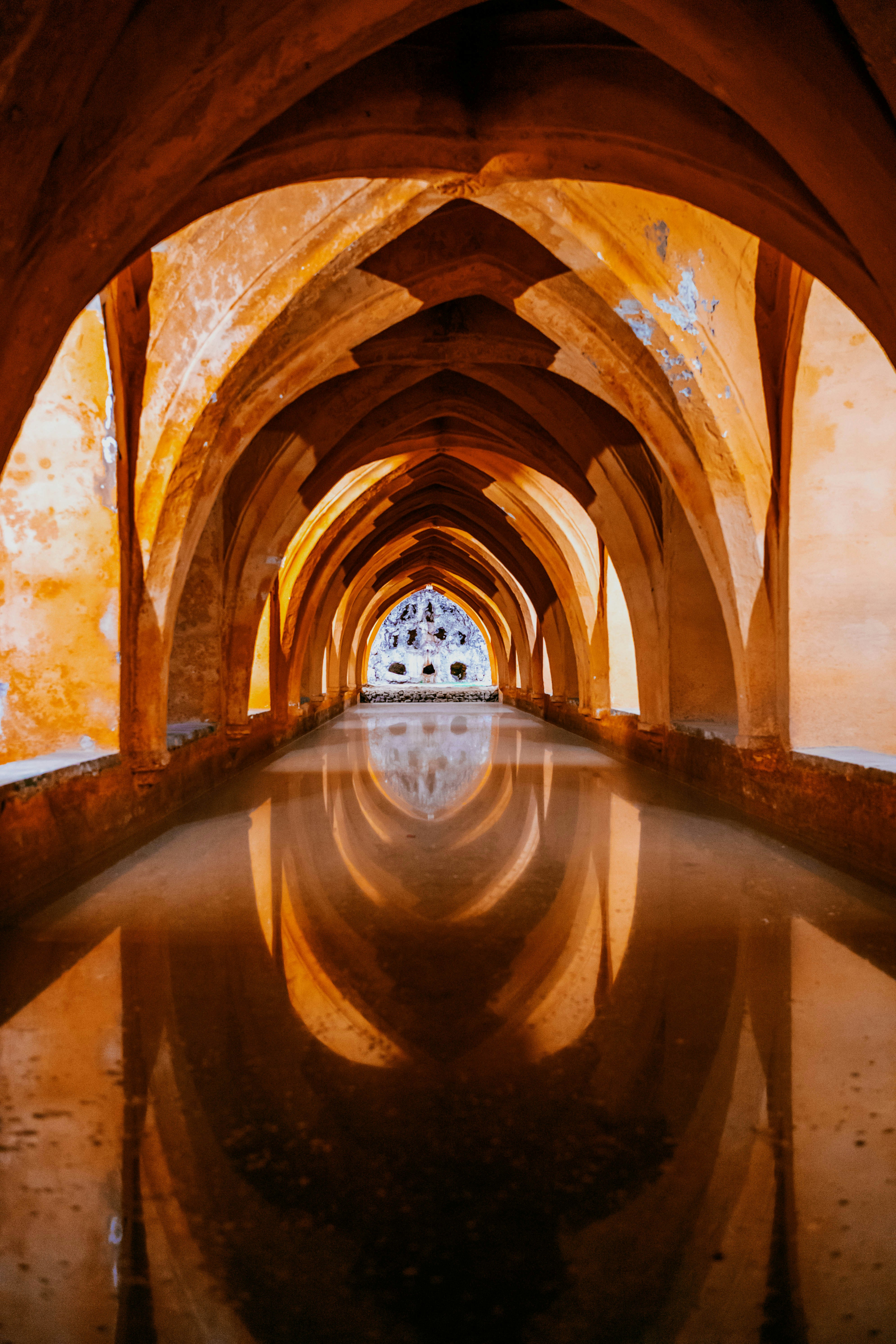 Archway Reflections: A Vaulted Passage Framed by Water and Light
