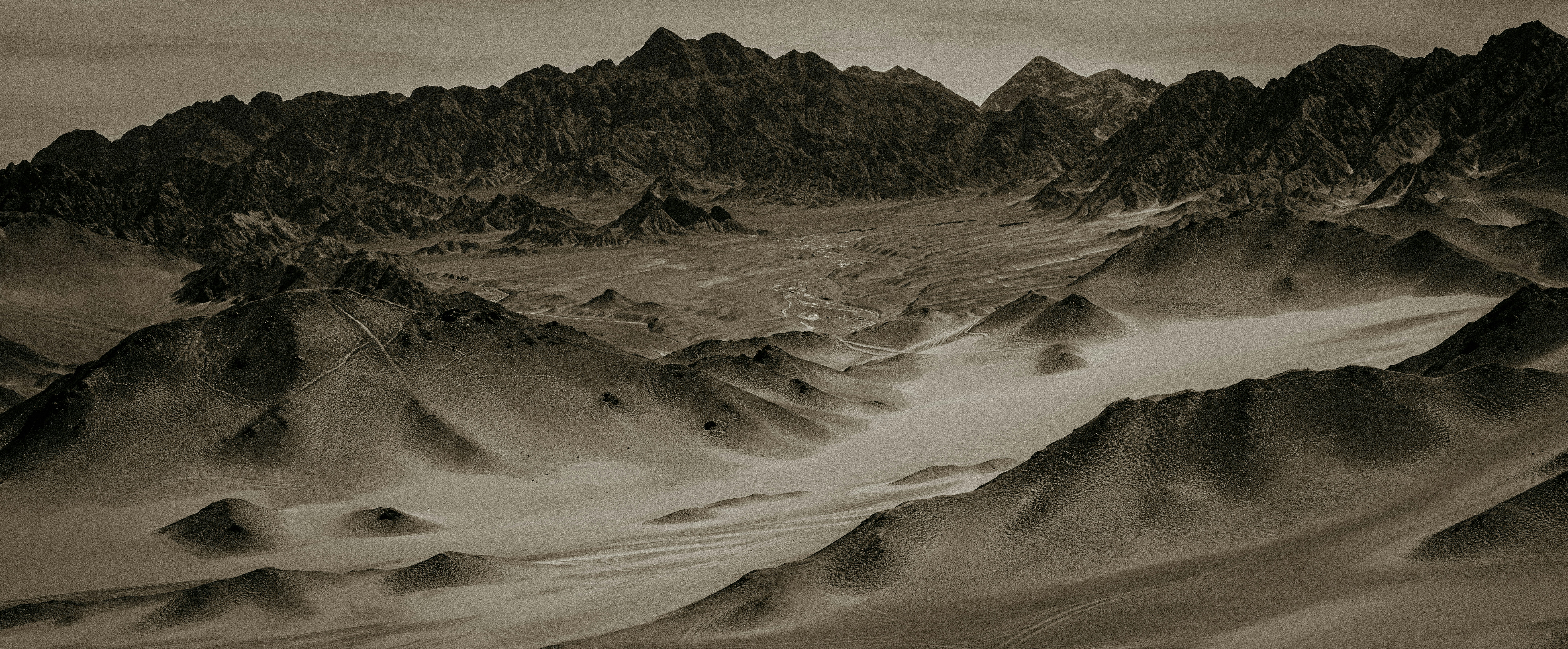 Whispers of Dune Giants: A Sea of Shadows Over Rugged Basins