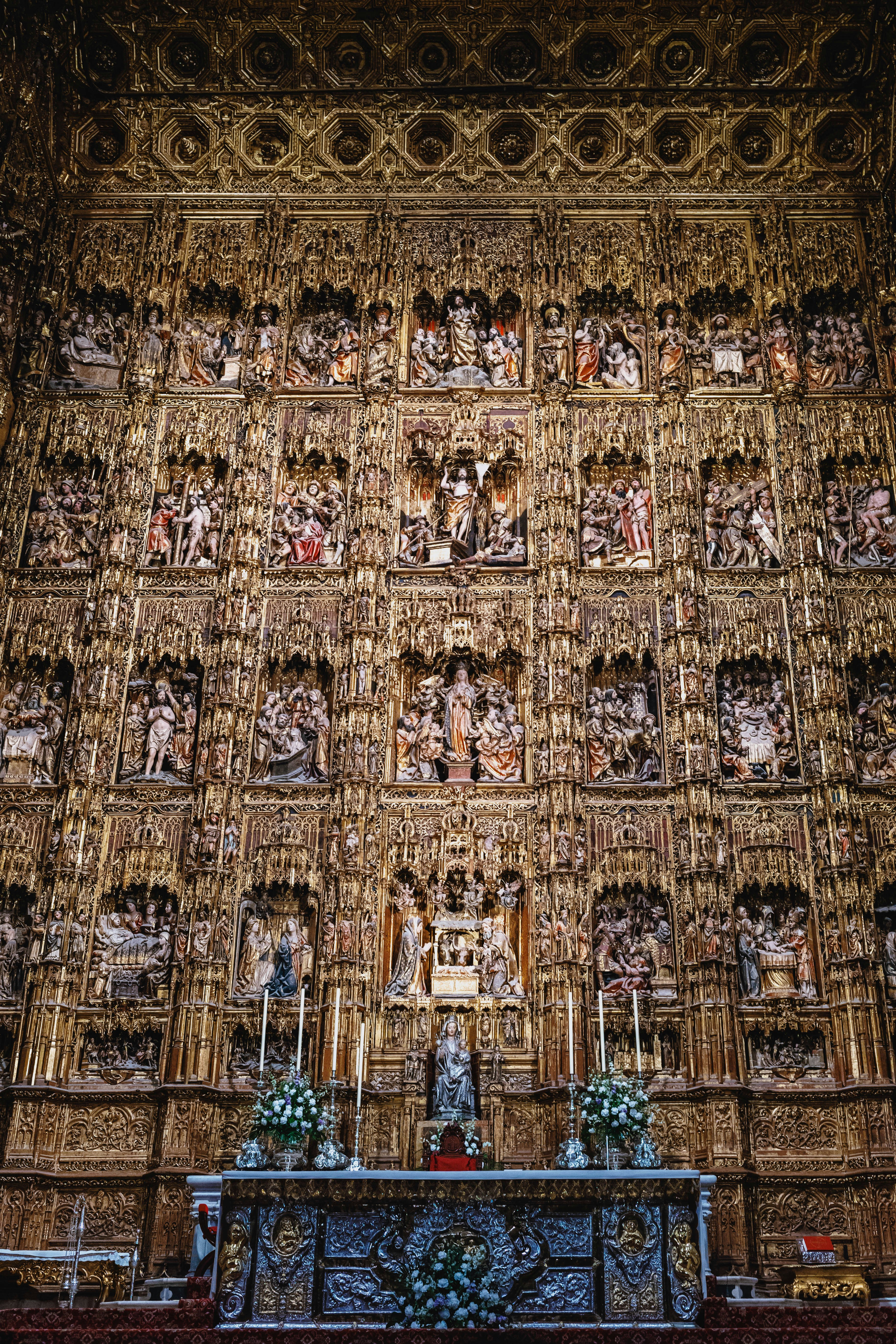 Gilded altarpiece: a library of saints and scenes carved in gold