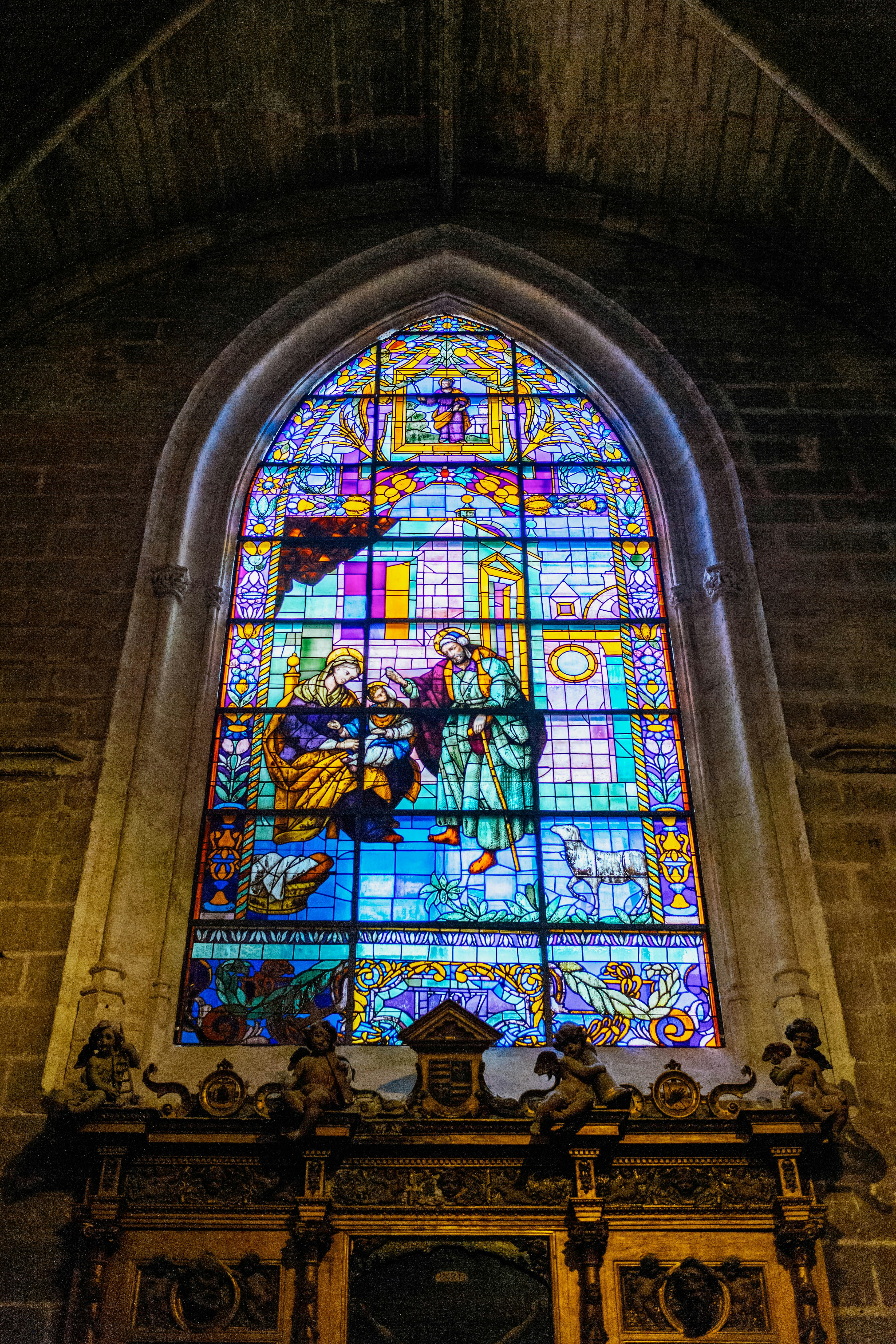 Stained Glass Reverie: A Nativity Panel Illuminated within Gothic Arches