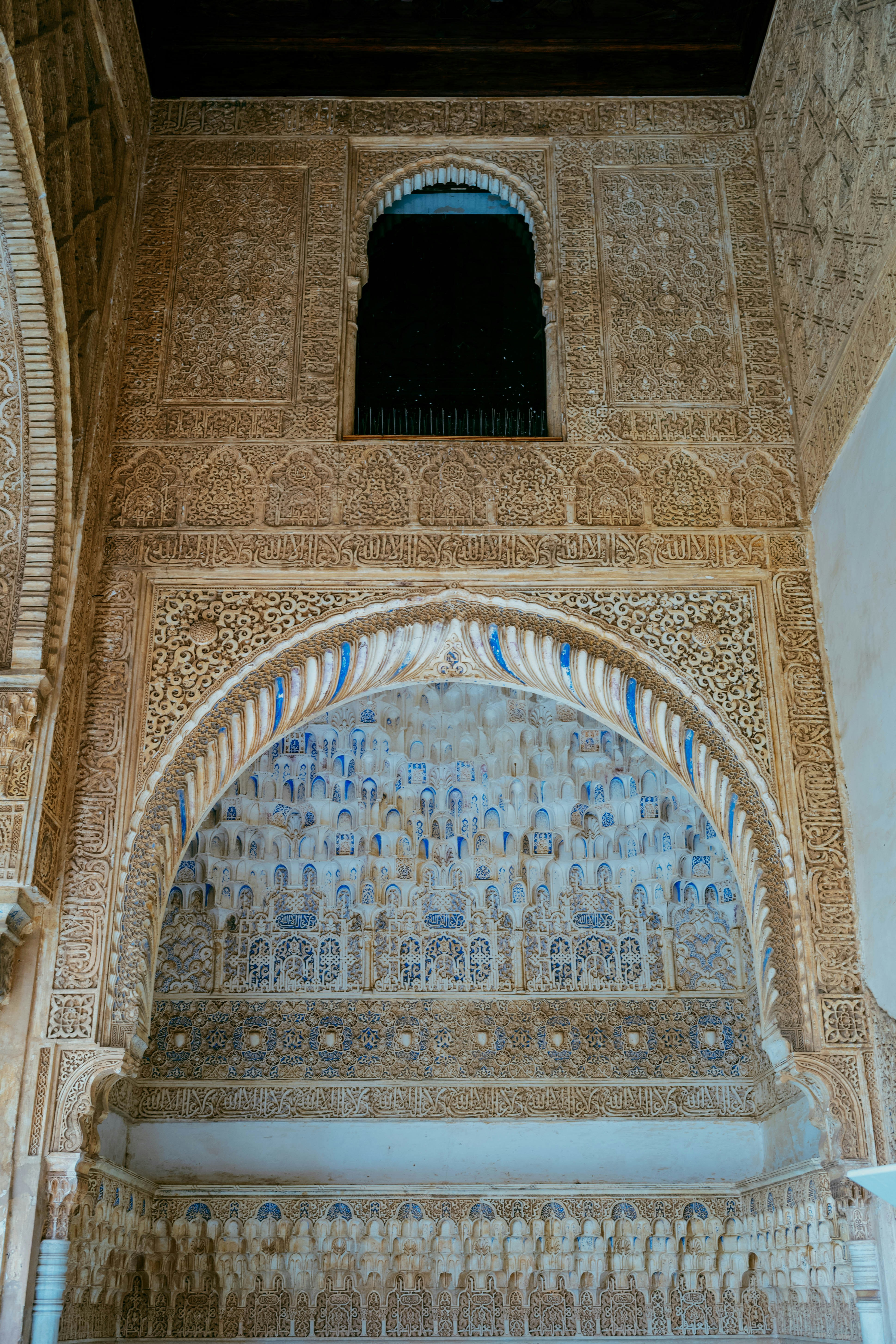 Carved Alcove of Blind Arch: A Close-up of Intricate Stucco and Tilework in a Desert Citadel