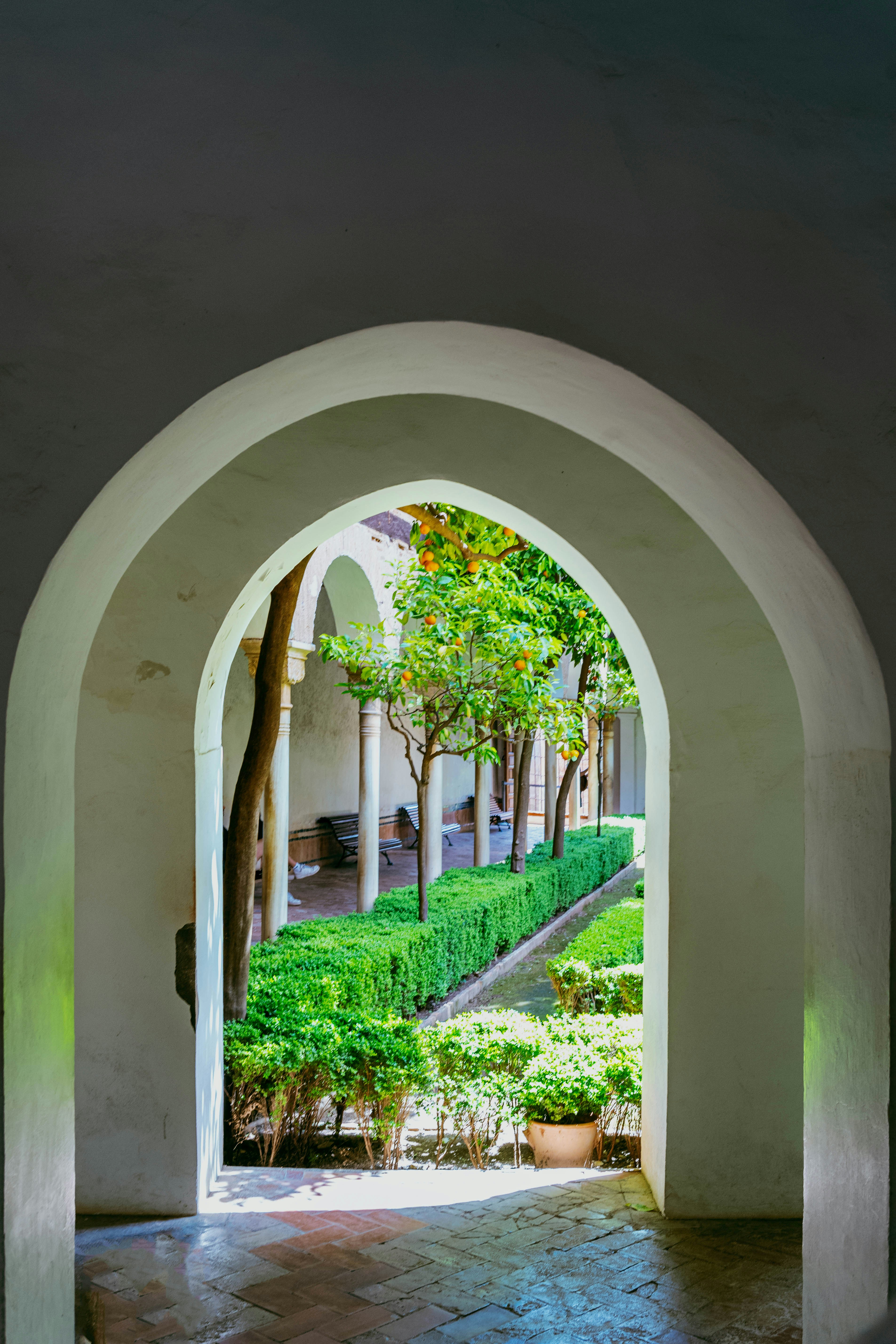 Archway to a Sunlit Garden Corridor