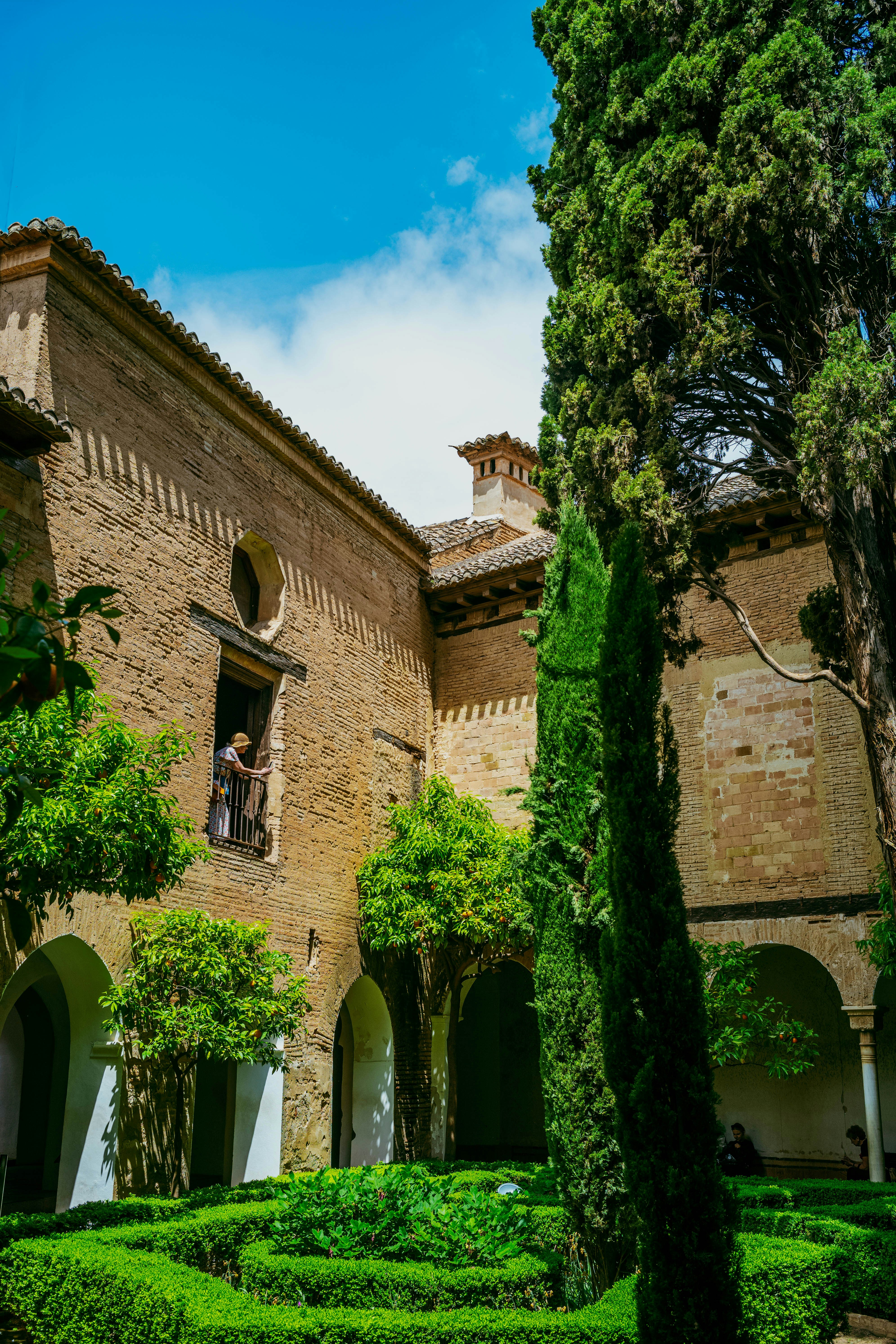 Cloistered Garden with a Facade of Brick and Tall Cypress