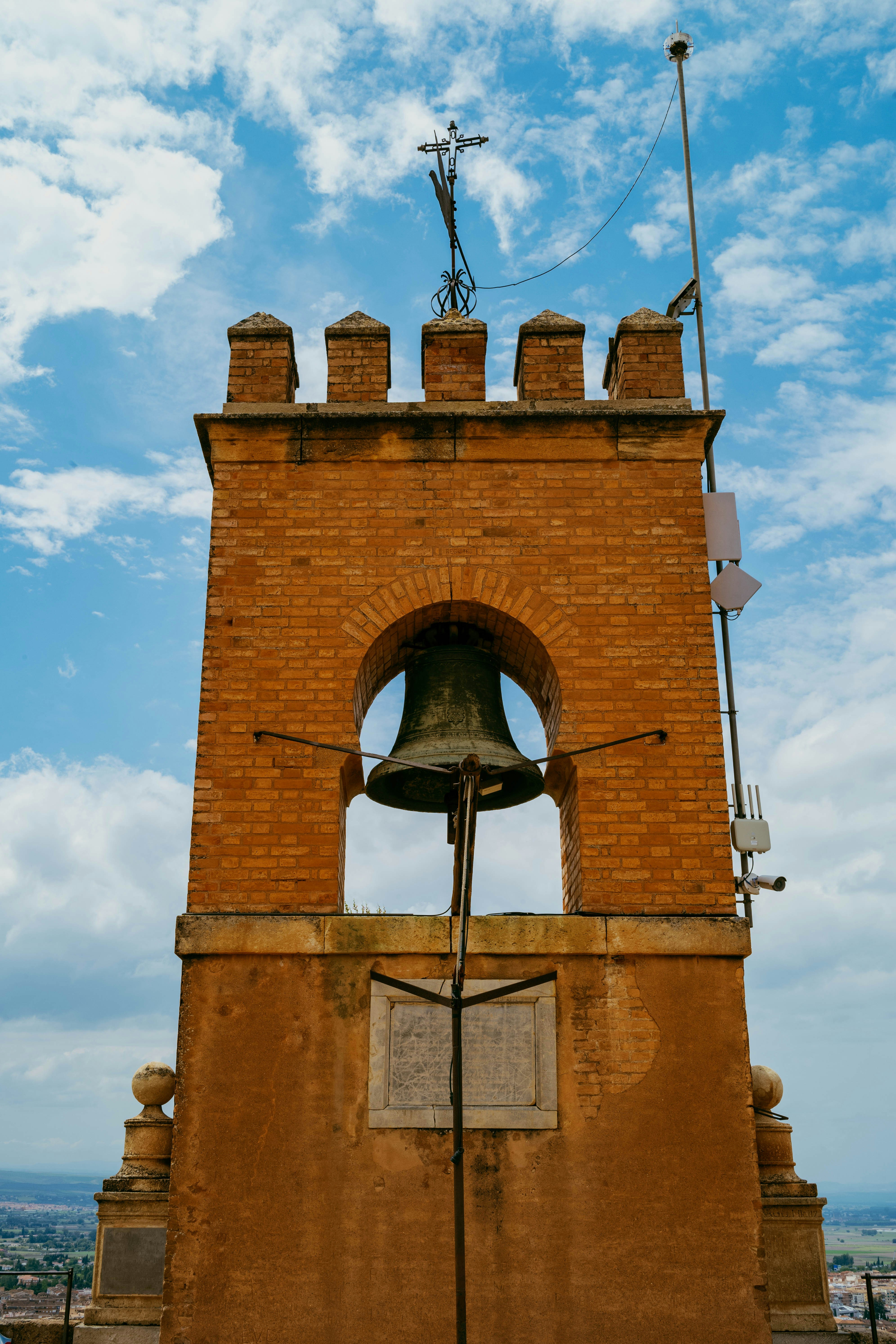 Bronze Bell Tower Rising Above the Placid Landscape