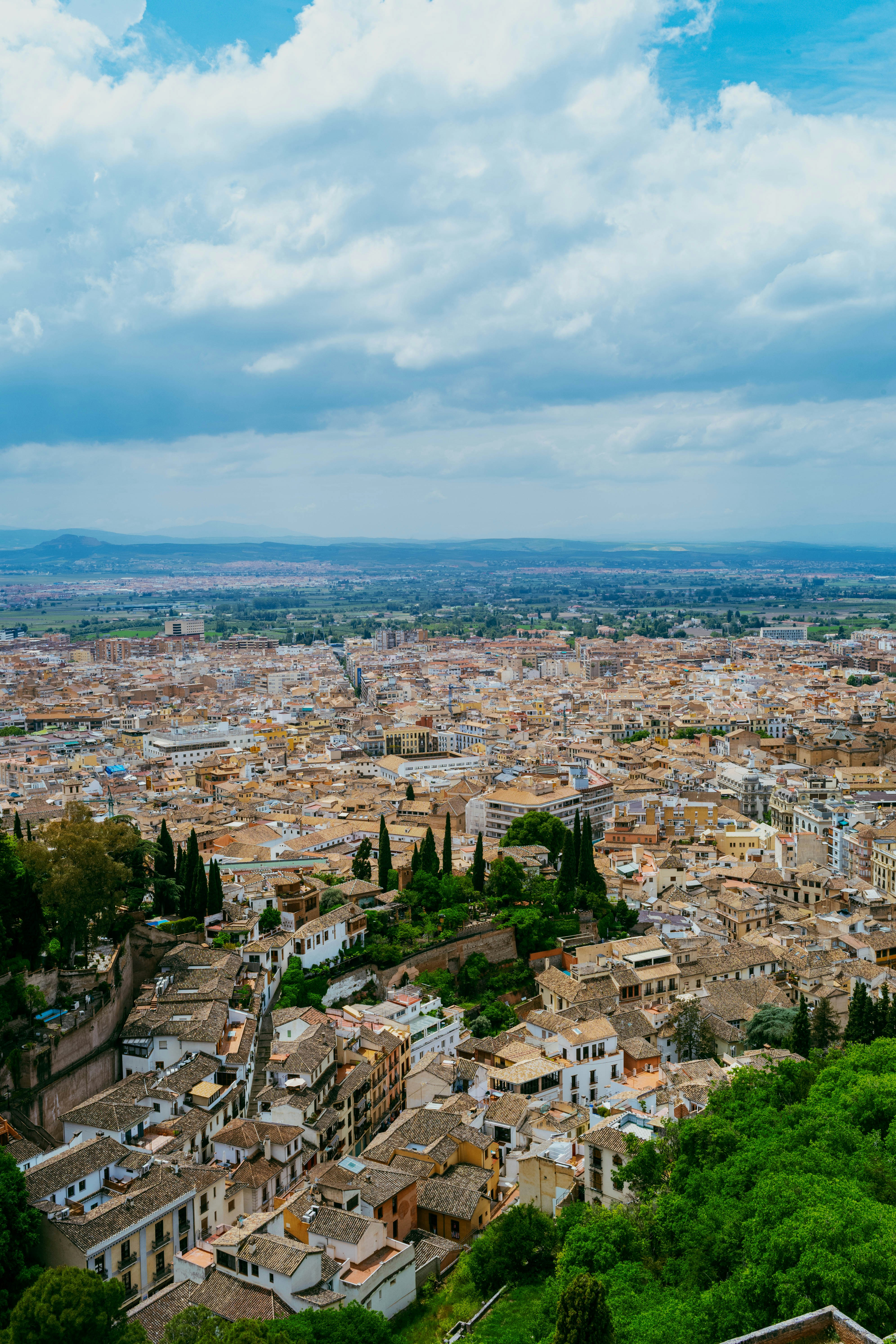 Terracotta rooftops cascading through a sunlit Andalusian valley