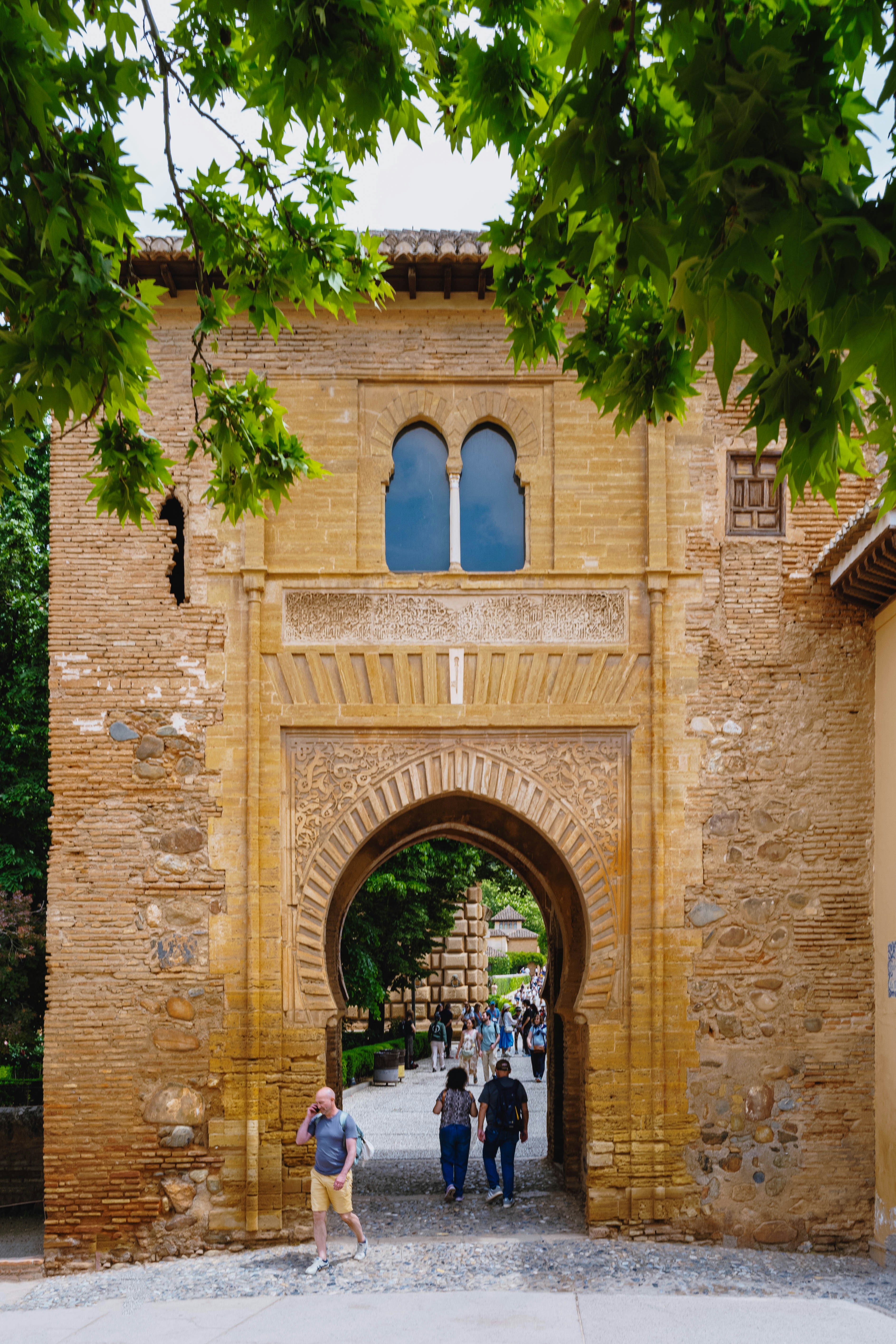 Gateway Through Time: Tourists beneath thearched brick arch