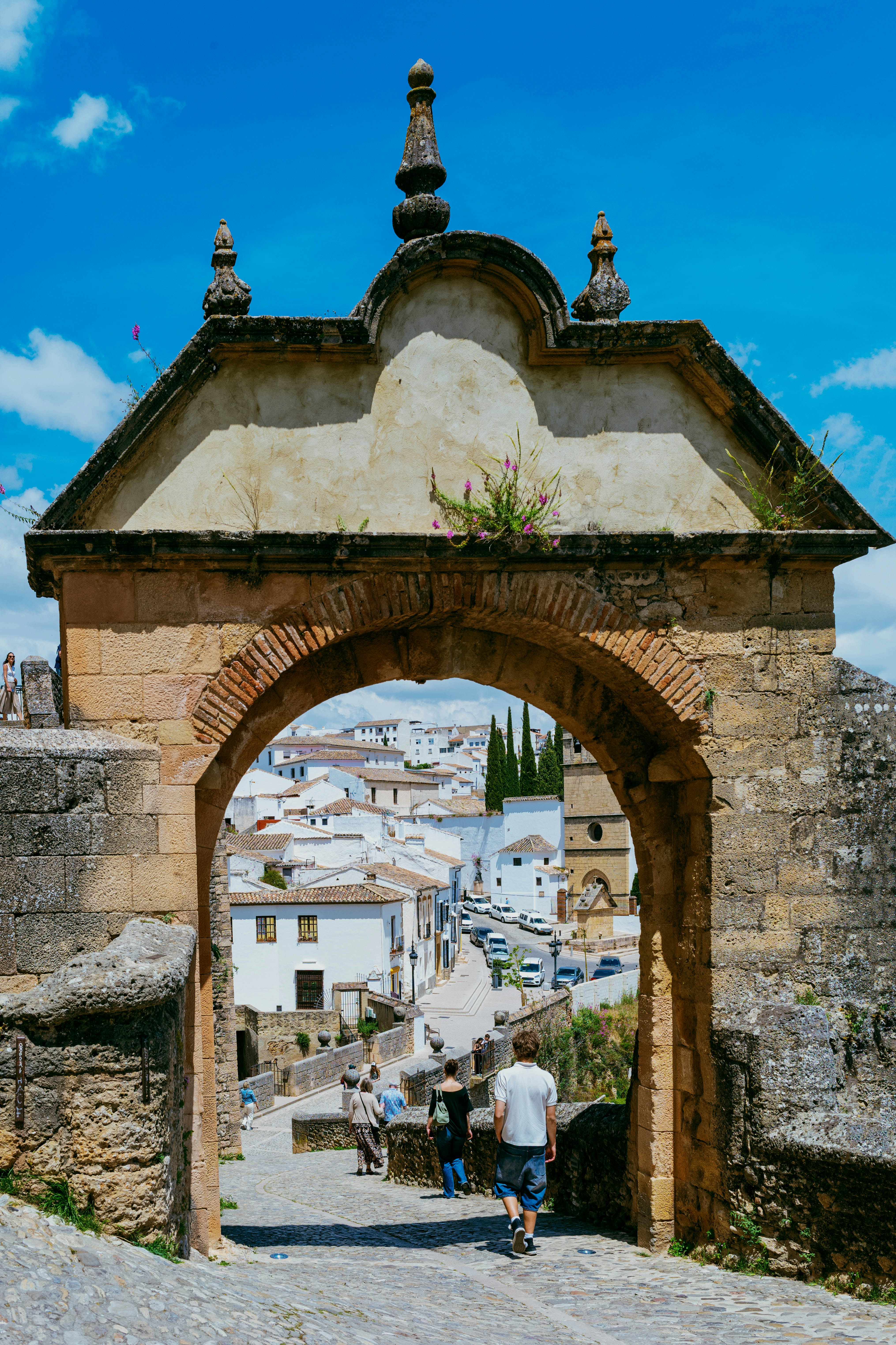 Through the Stone Archway: A Sunlit Village Walk