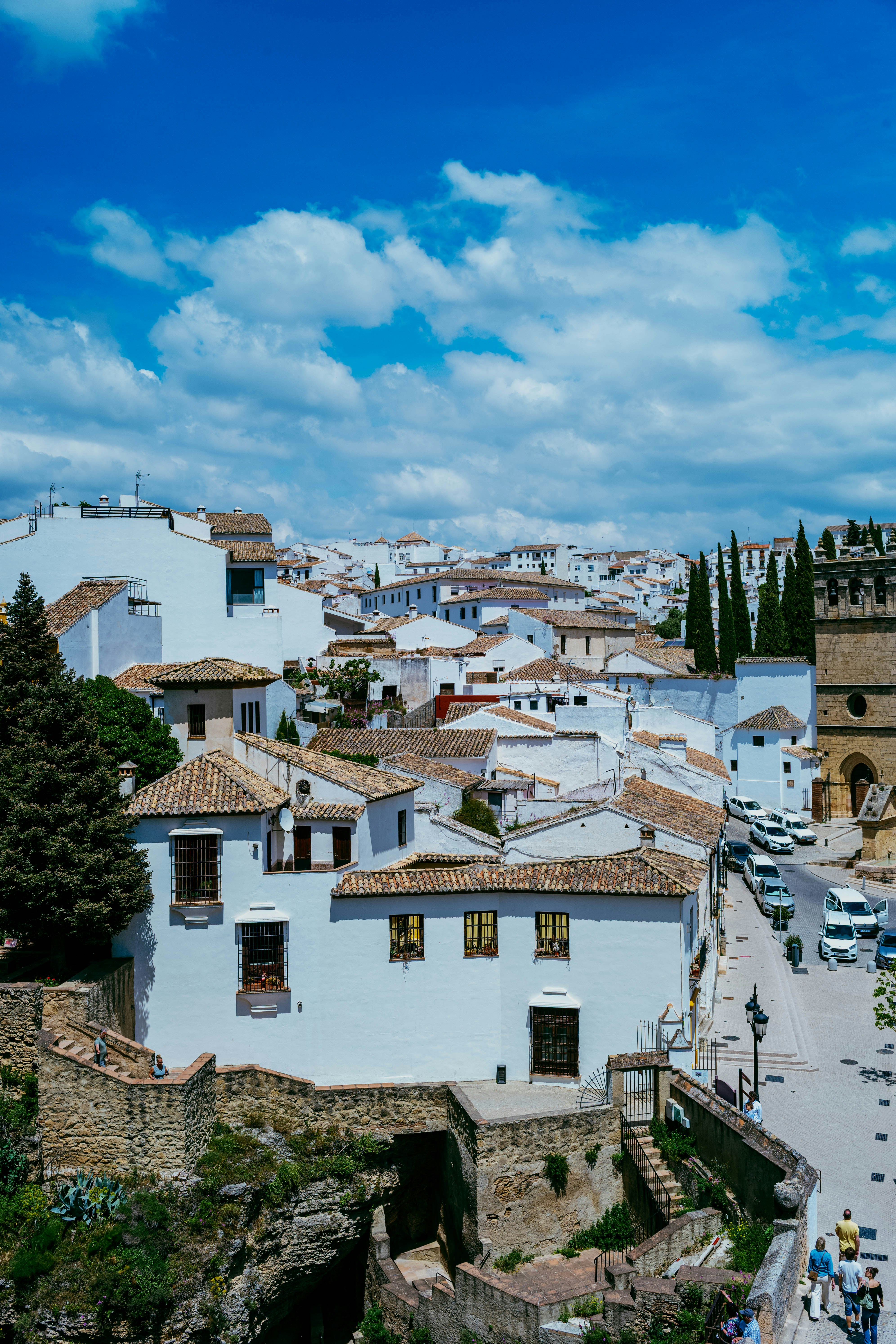 White-washed village rooftops under a blue Andalusian sky