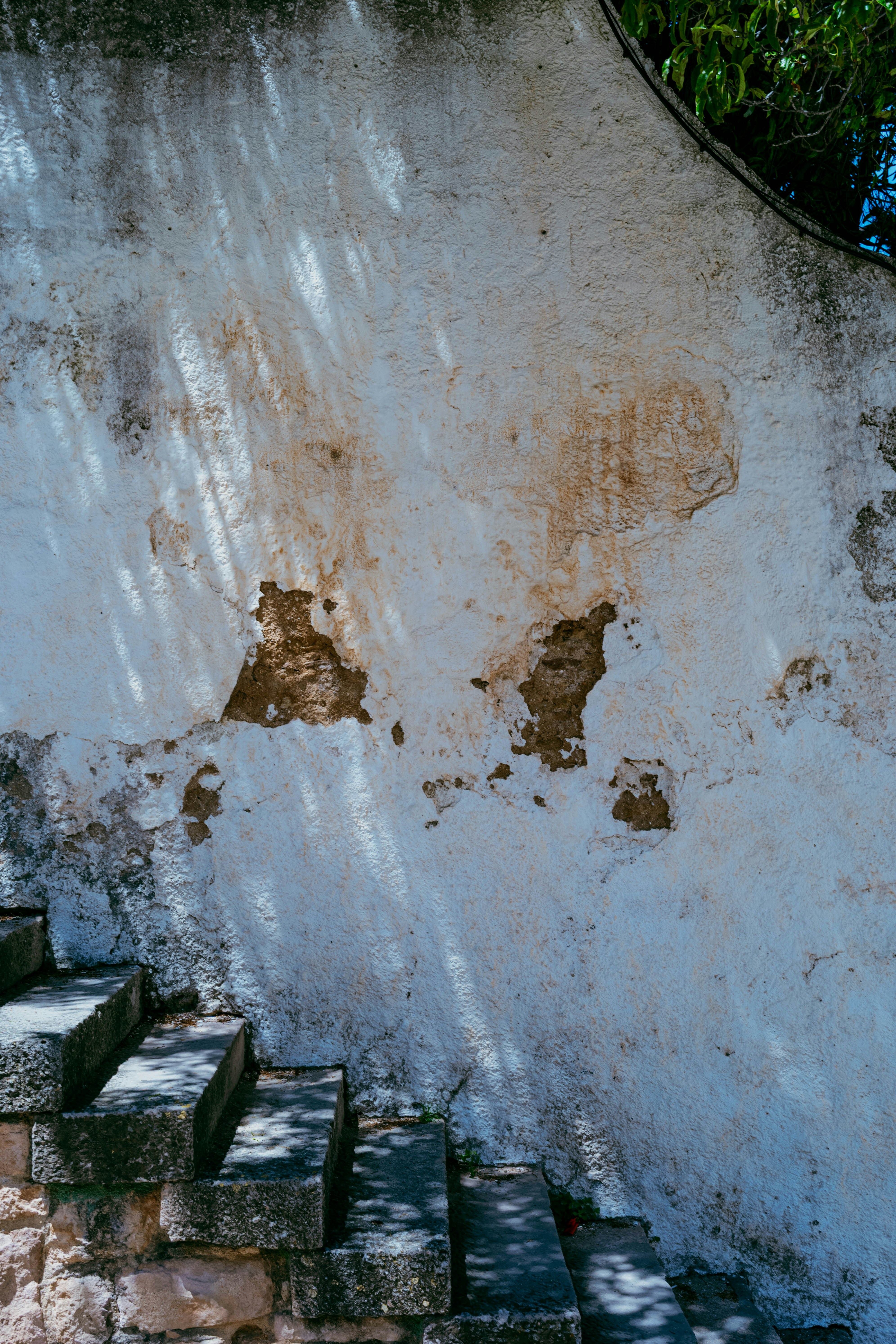 Weathered Wall and Shaded Steps: Echoes of Light on Timeworn Stone