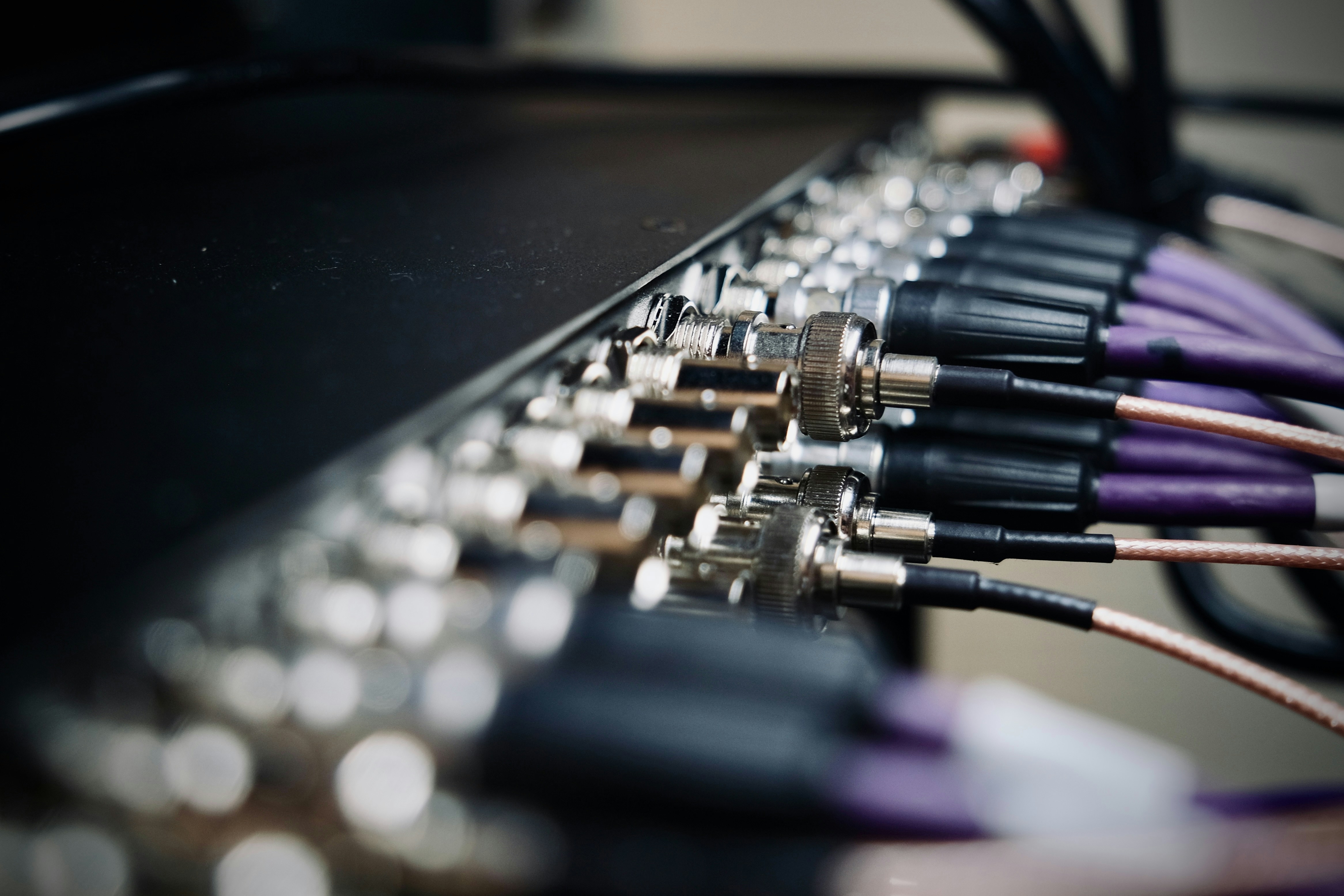 Cables and Connectors in a Row: A Close-Up of a Soundboard's Conduits