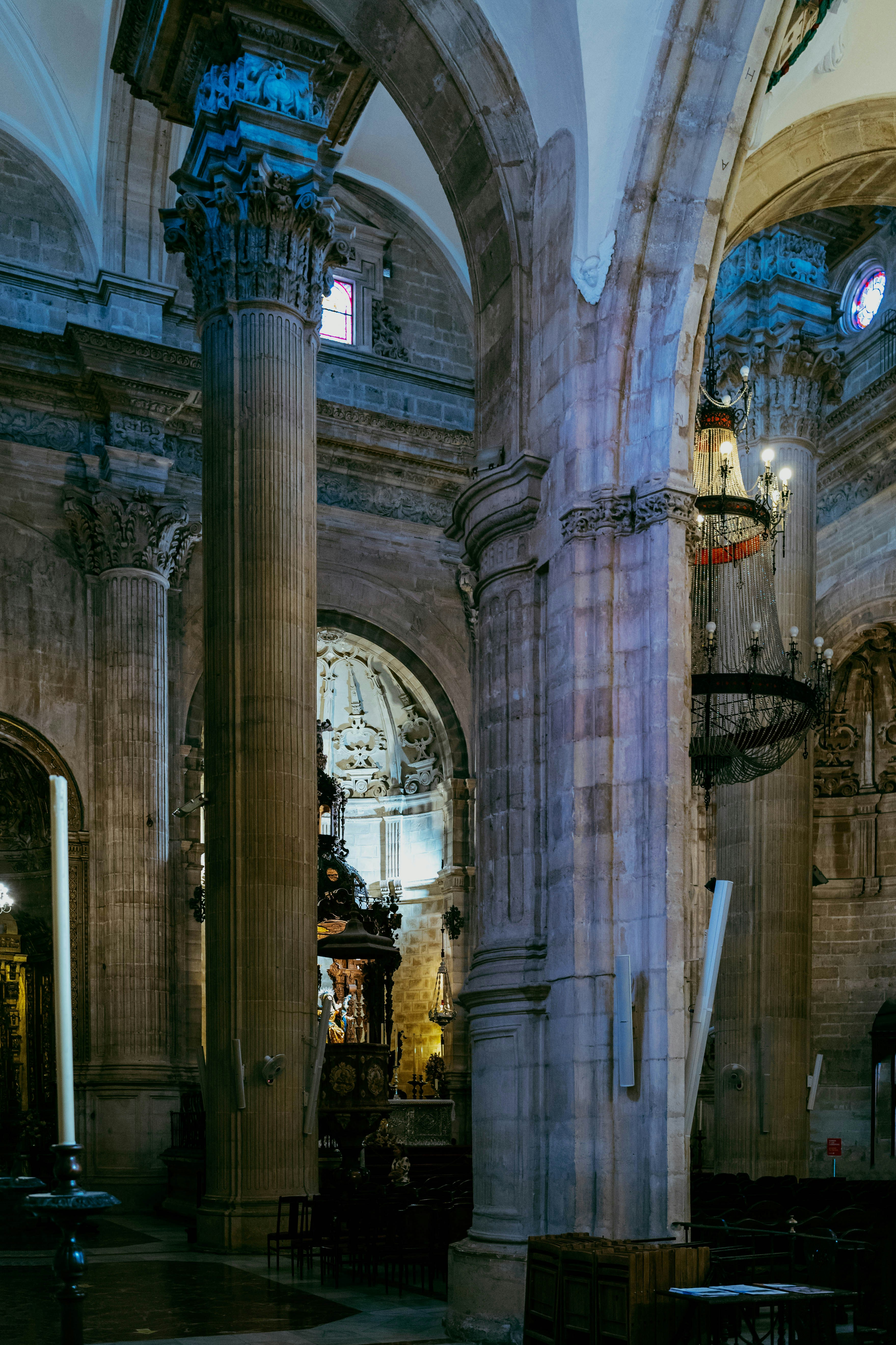 Cathedral in Blue: Ornate Columns and Silence Beneath Stained Glass